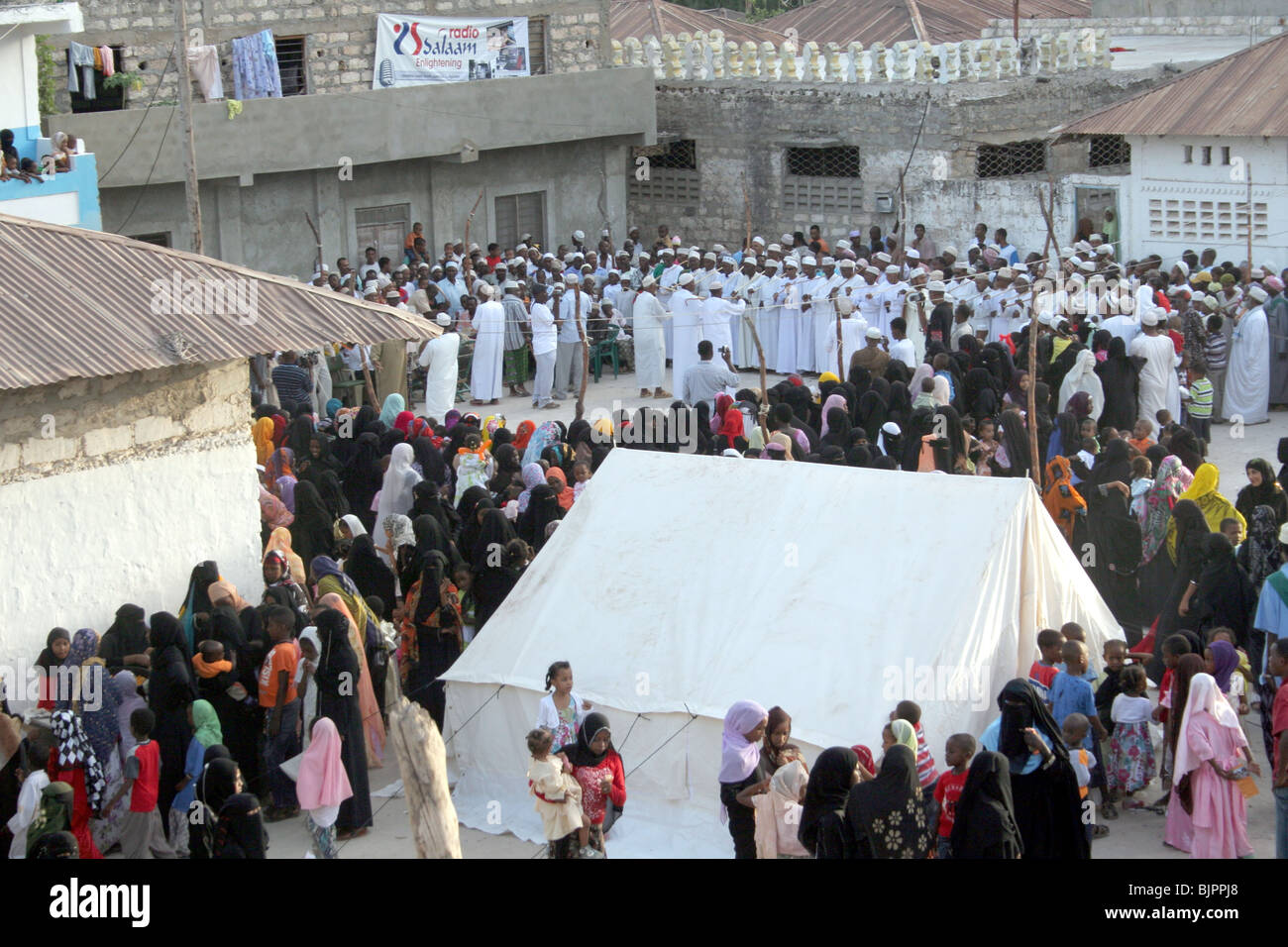 Swahili men and women celebrating Maulidi outside Riyadha Mosque Lamu ...