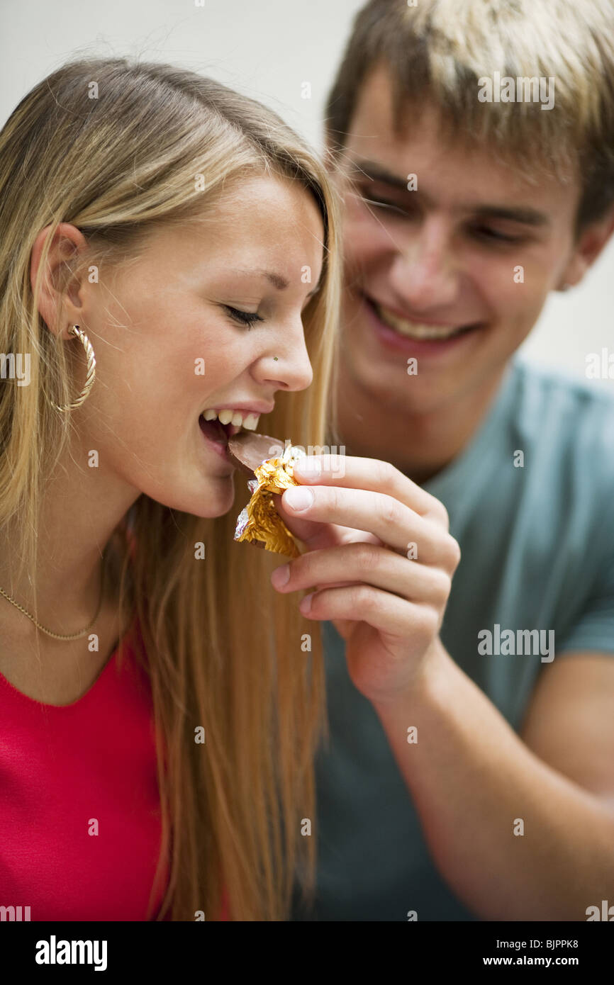 Couple eating chocolate Stock Photo - Alamy