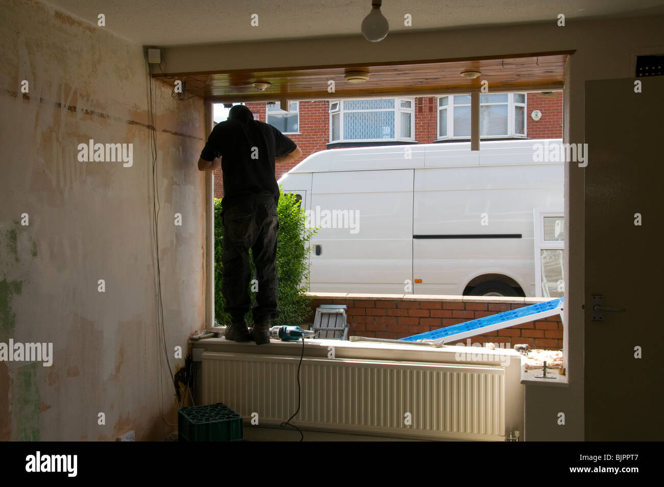 New uPVC windows being fitted to the front of a terraced house ...