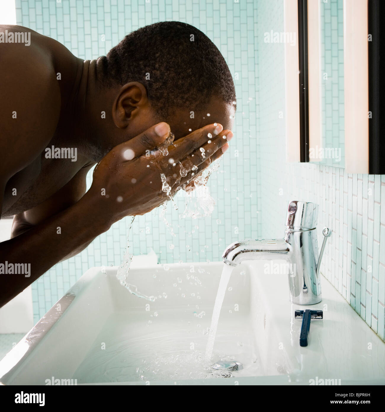 Male washing face Stock Photo - Alamy