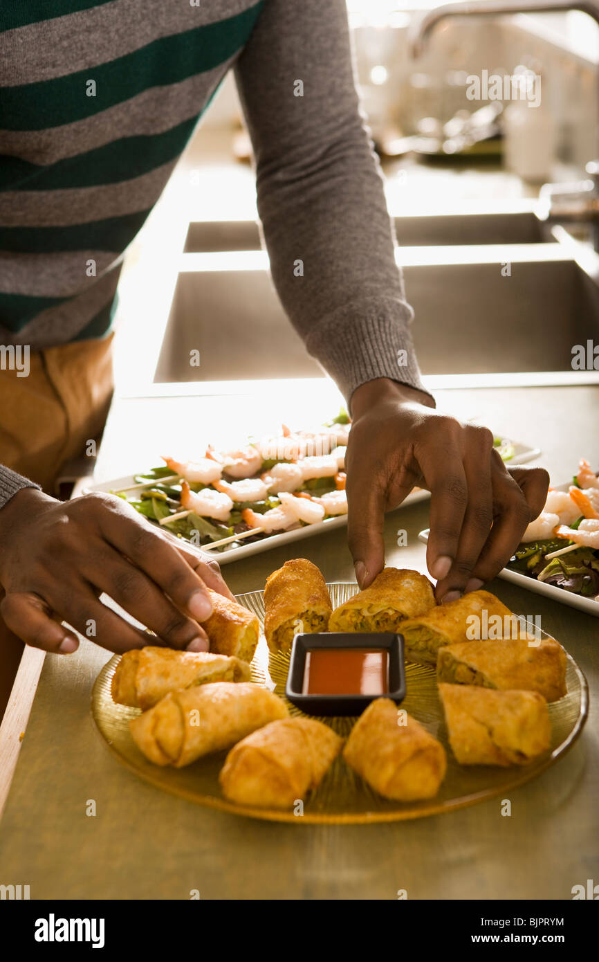 Man preparing appetizers Stock Photo - Alamy