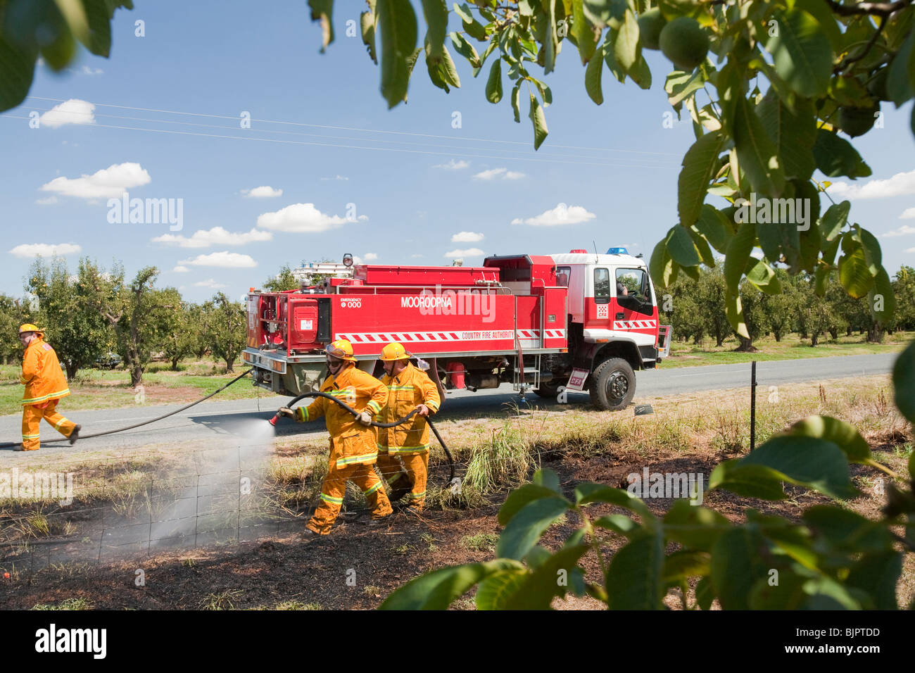 CFA fire fighters tackle a roadside fire near Shepperton, Victoria ...