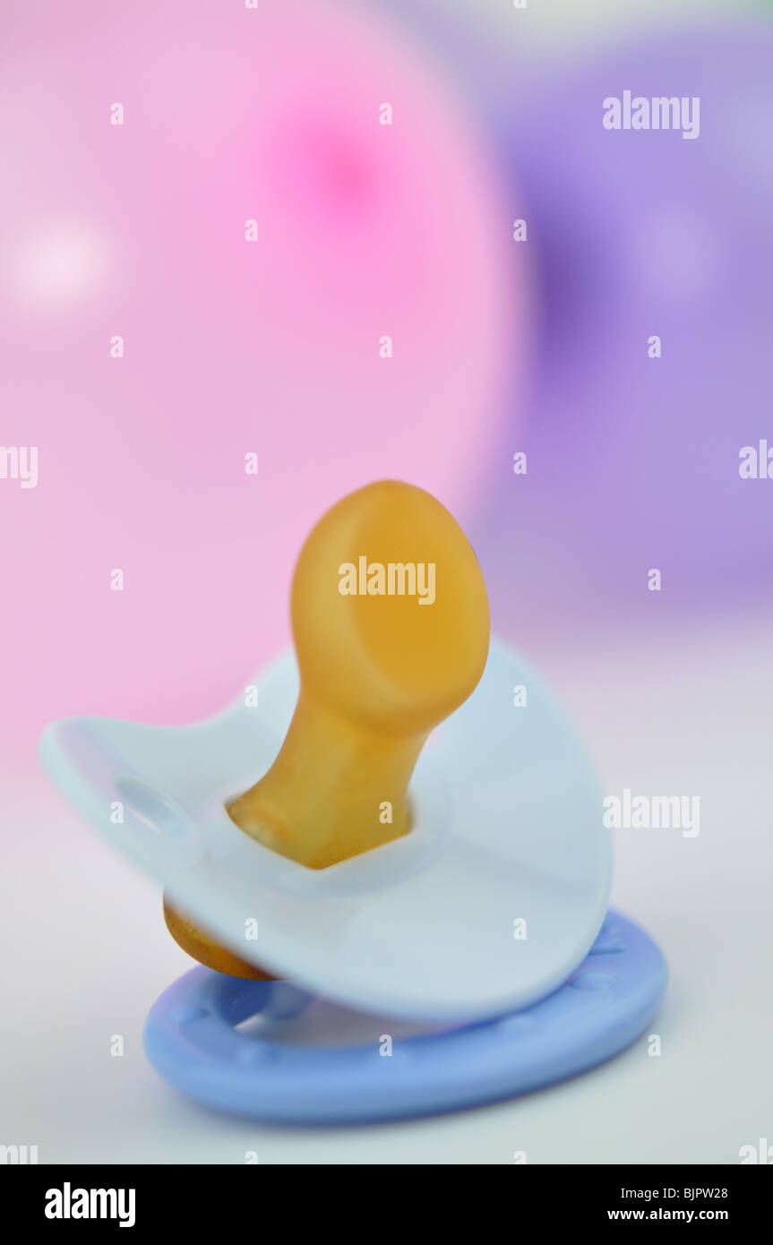 Blue pacifier and balloons Stock Photo - Alamy