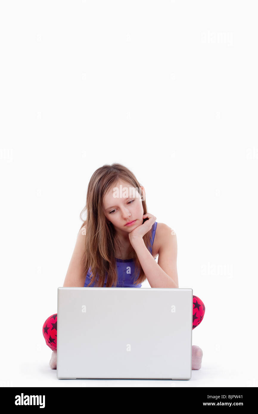 young girl sitting with laptop computer - isolated on white Stock Photo ...