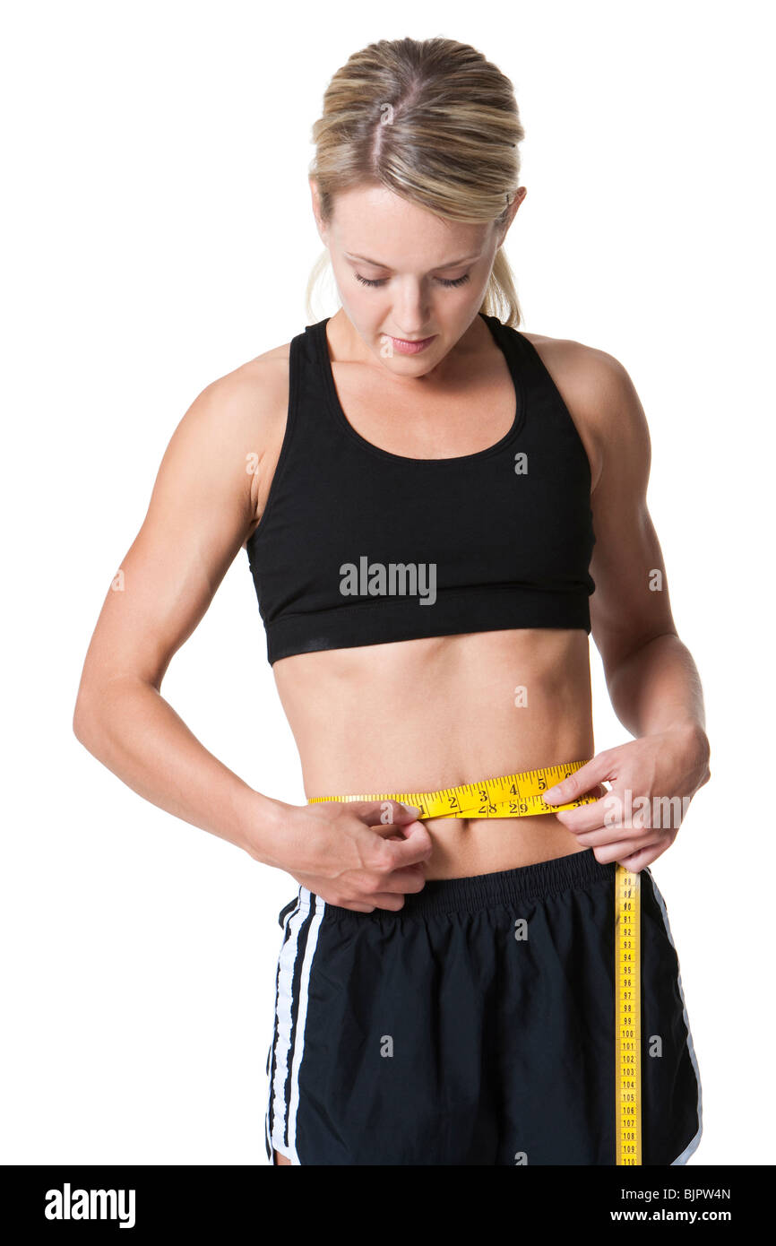 Woman measuring her waist Stock Photo - Alamy