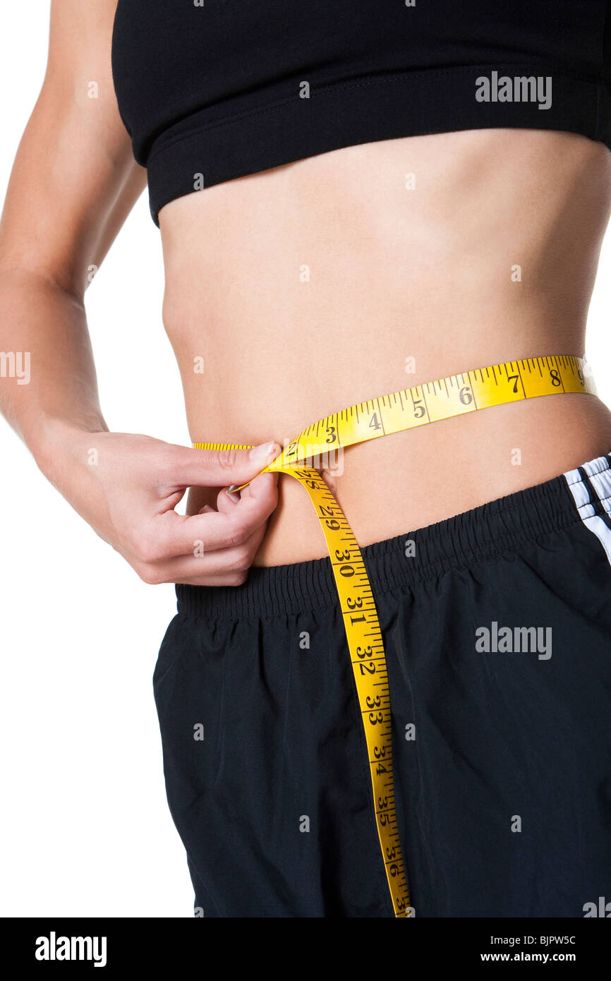 Woman measuring her waist Stock Photo - Alamy
