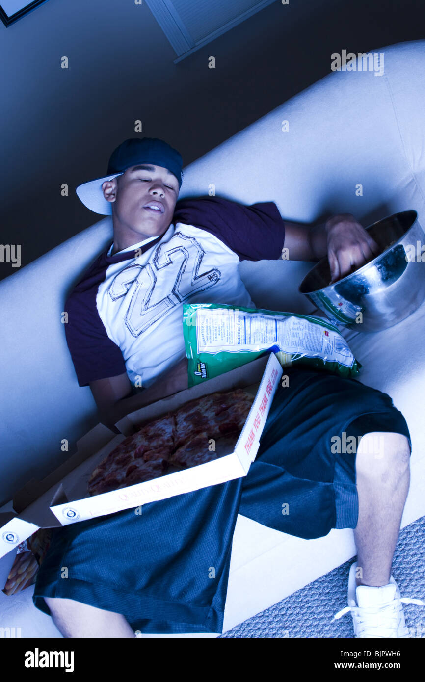 Man sleeping on a couch Stock Photo - Alamy