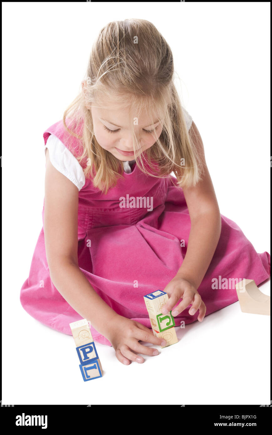 Girl playing with blocks Stock Photo - Alamy