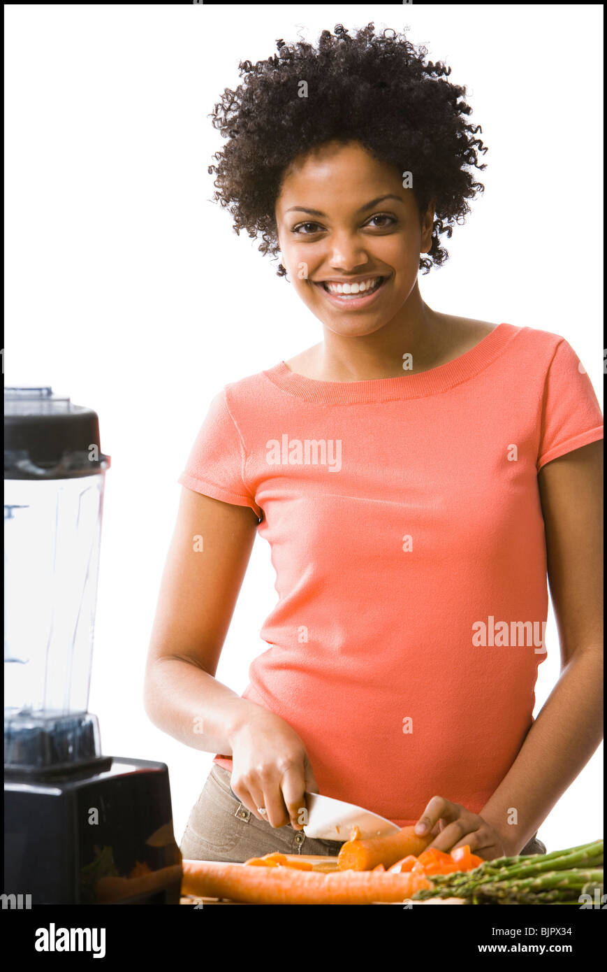 Black woman slicing vegetables hi-res stock photography and images - Alamy
