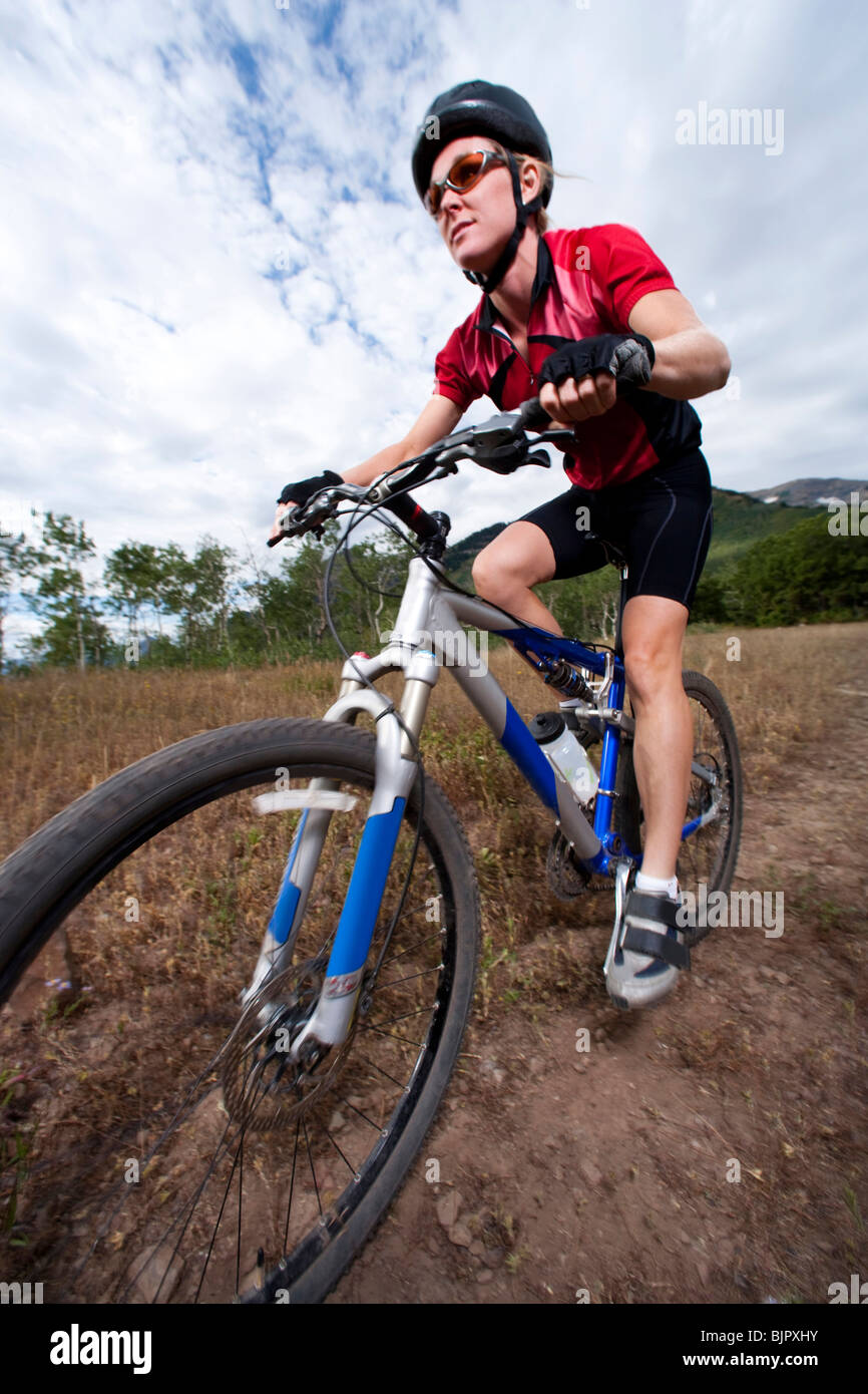 Woman biking on path outside Stock Photo - Alamy
