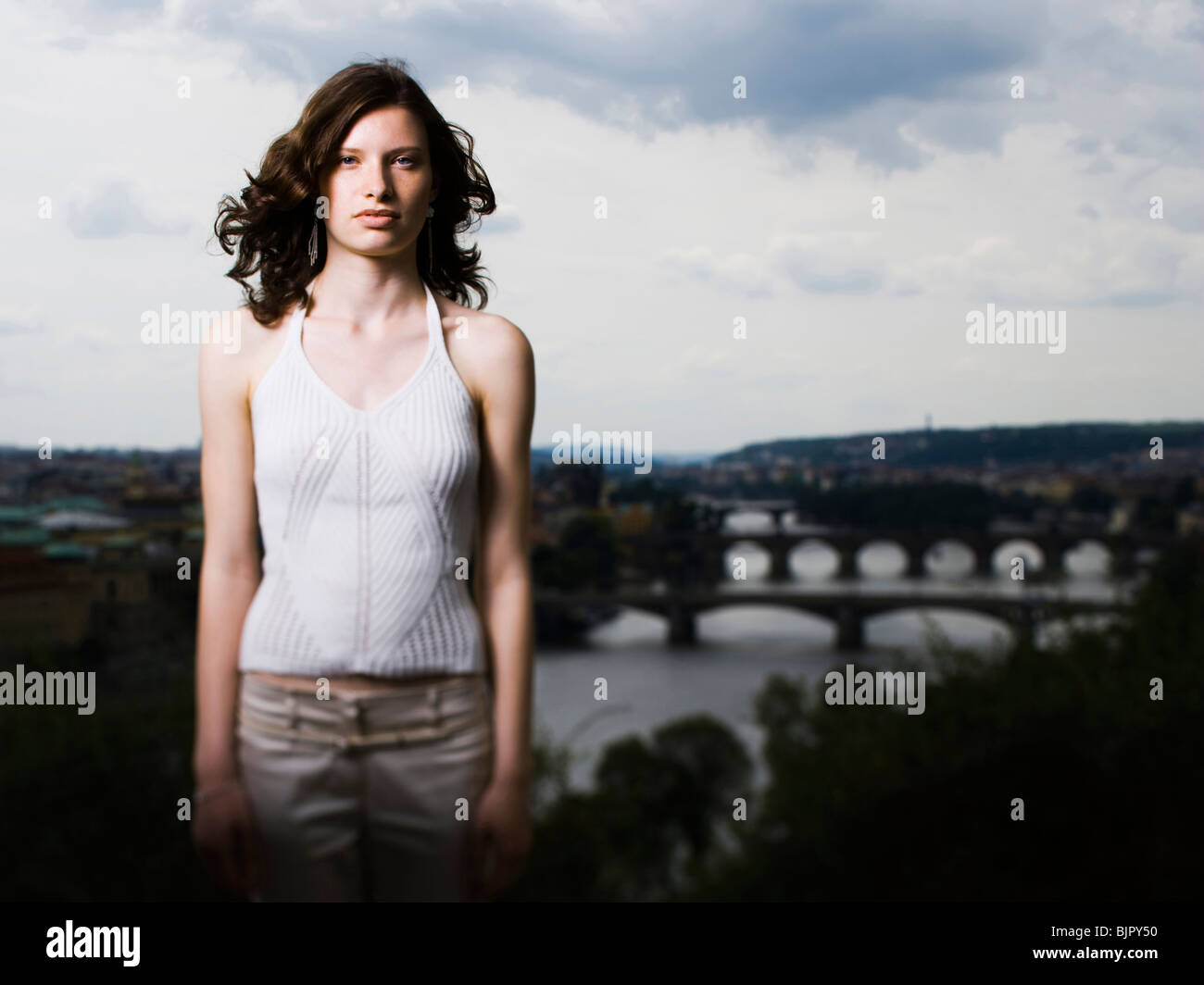 Woman outside in front of bridges Stock Photo - Alamy