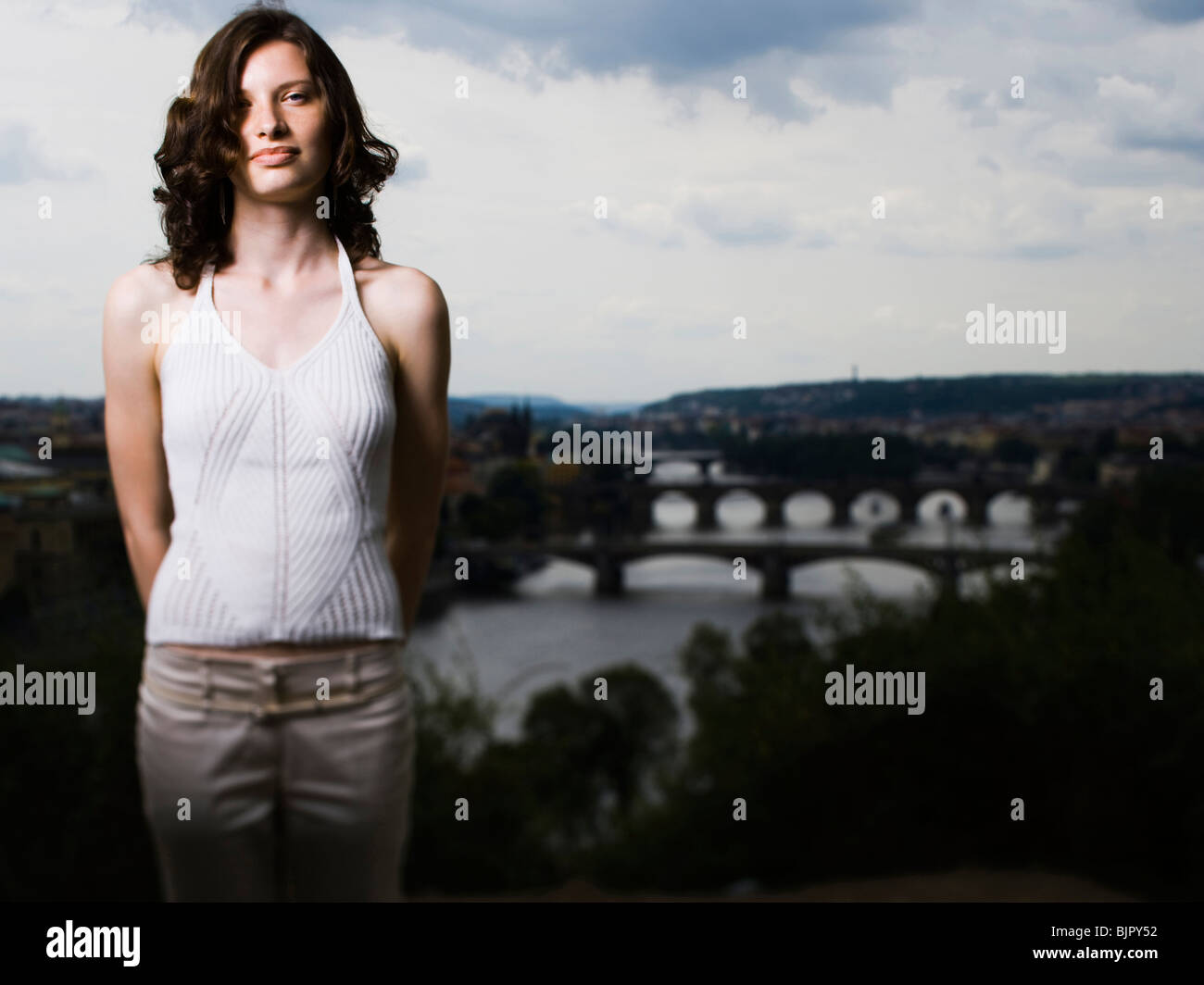 Woman outside in front of bridges Stock Photo - Alamy