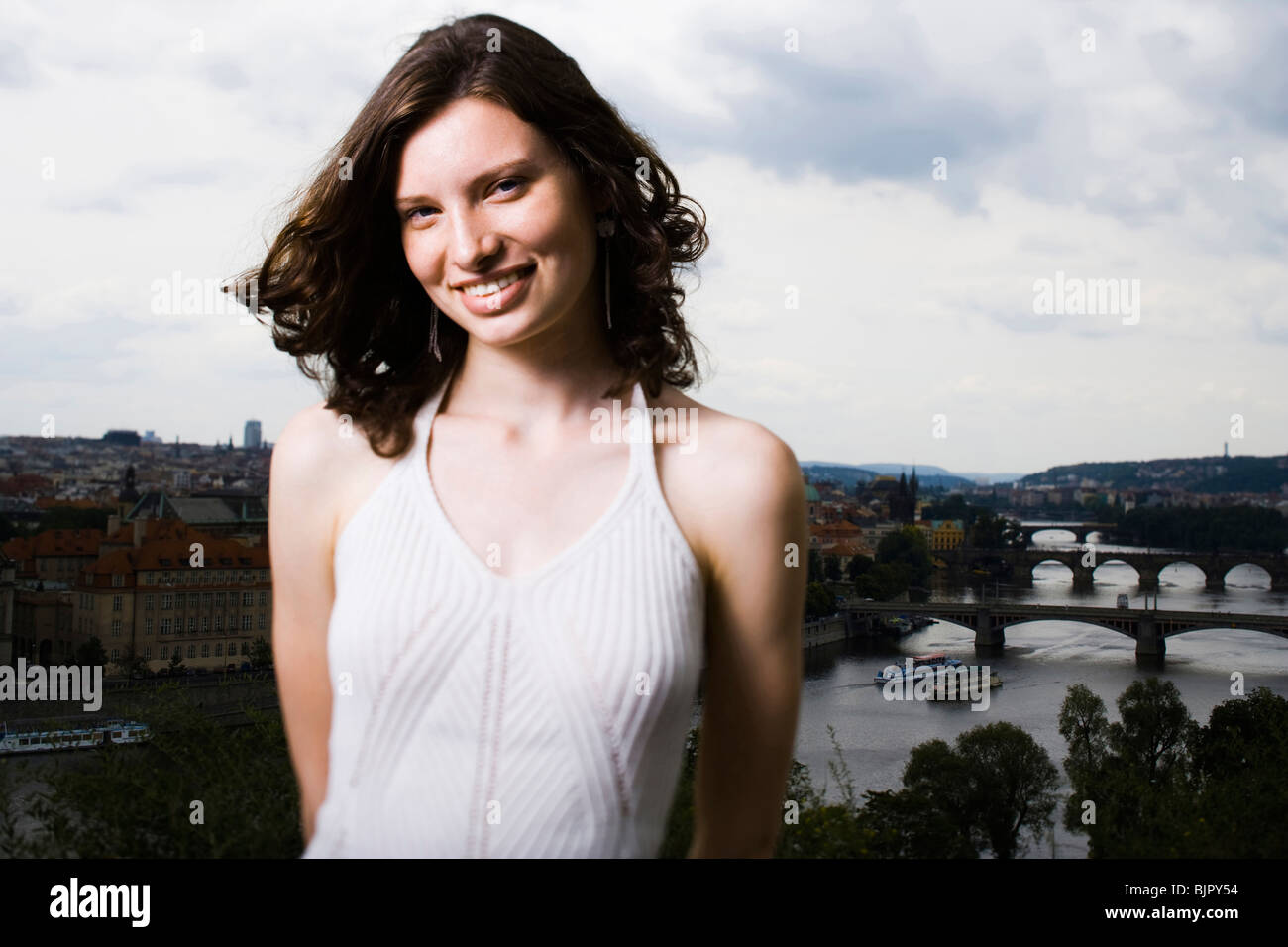 Woman outside in front of bridges Stock Photo - Alamy