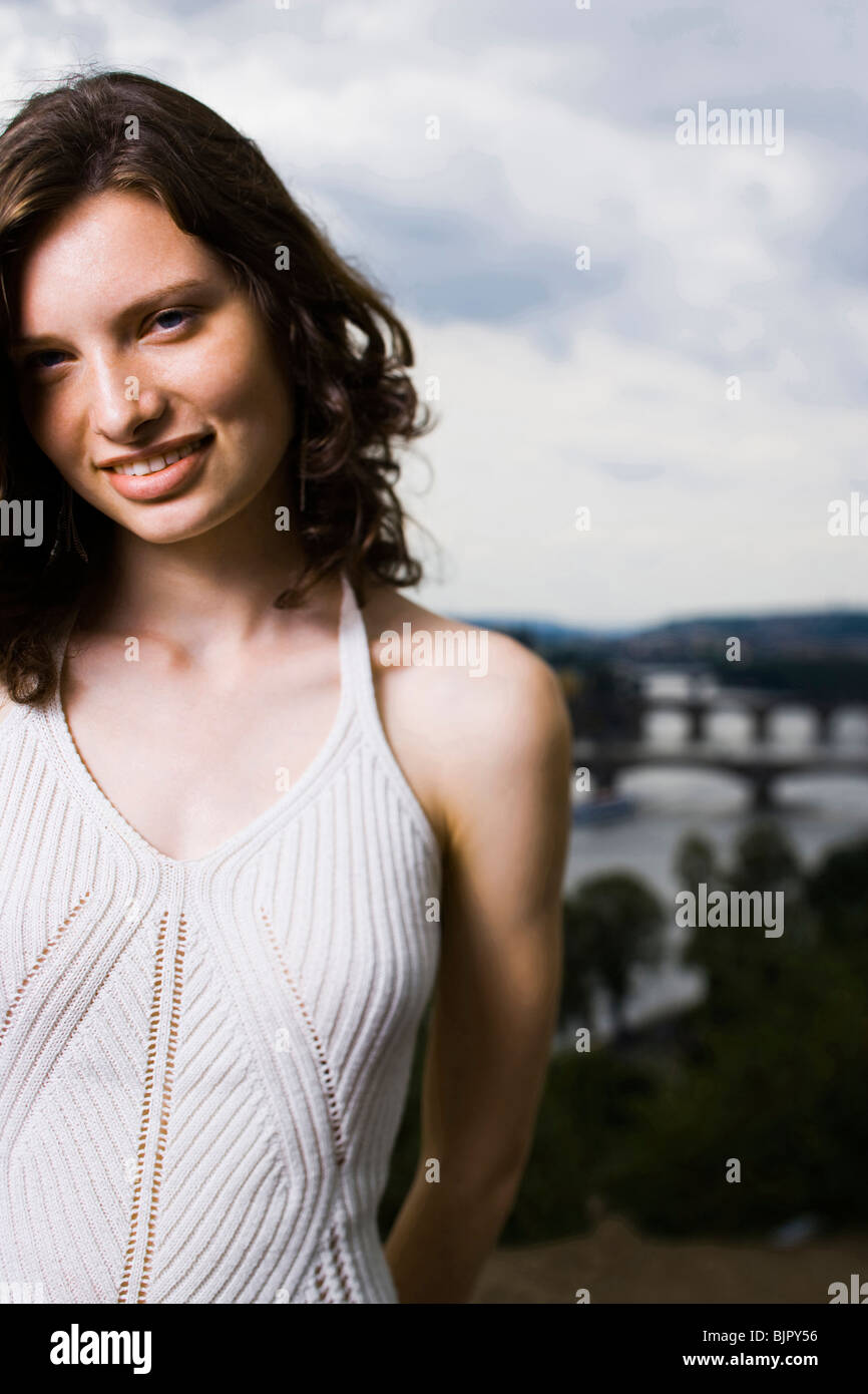 Woman outside in front of bridges Stock Photo - Alamy