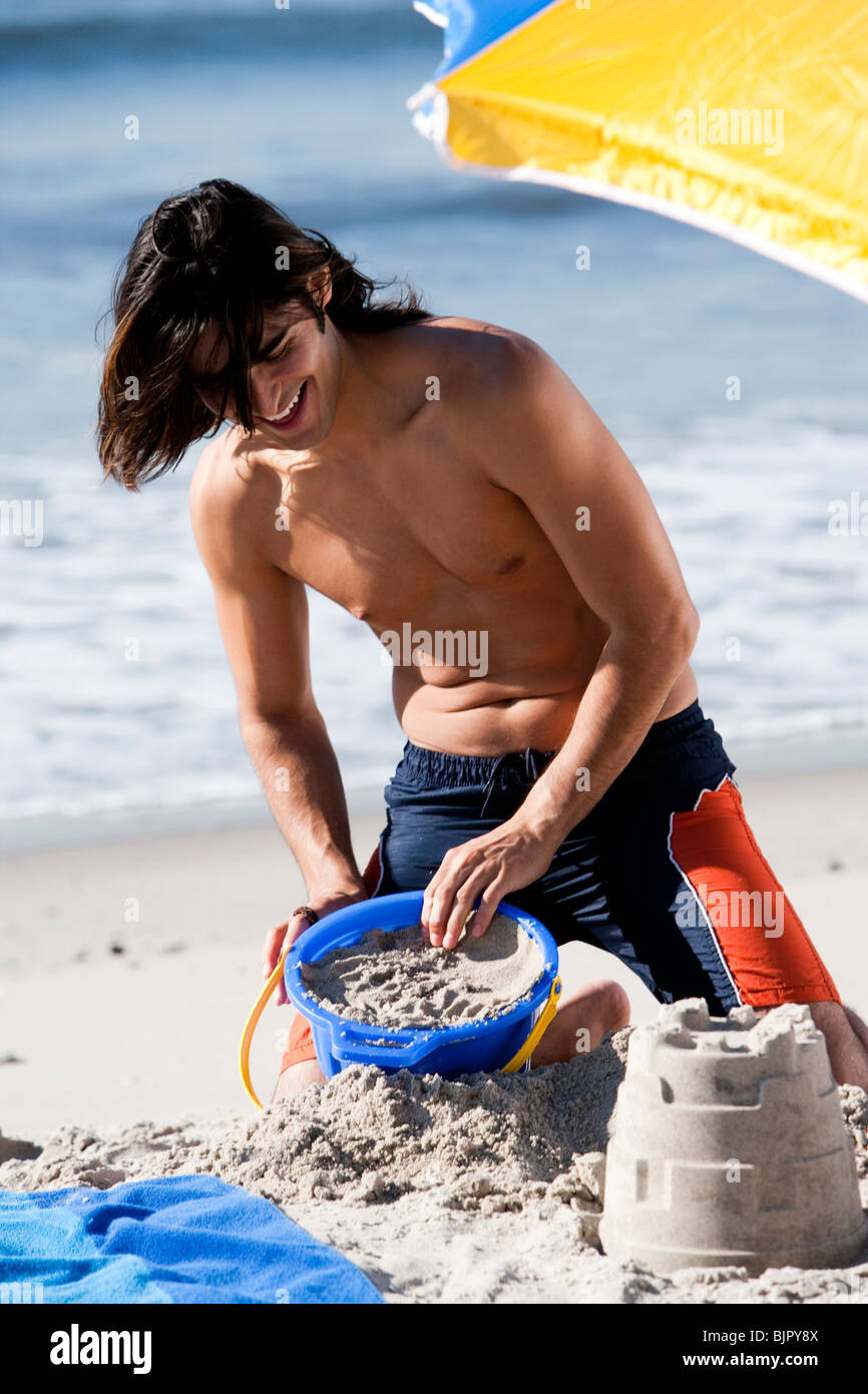 Man building a sand castle Stock Photo - Alamy