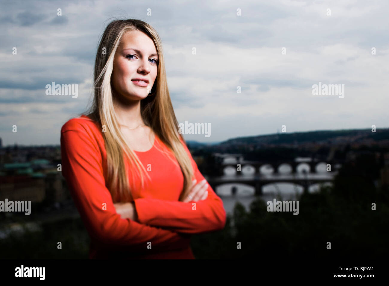 Woman outside in front of bridges Stock Photo - Alamy