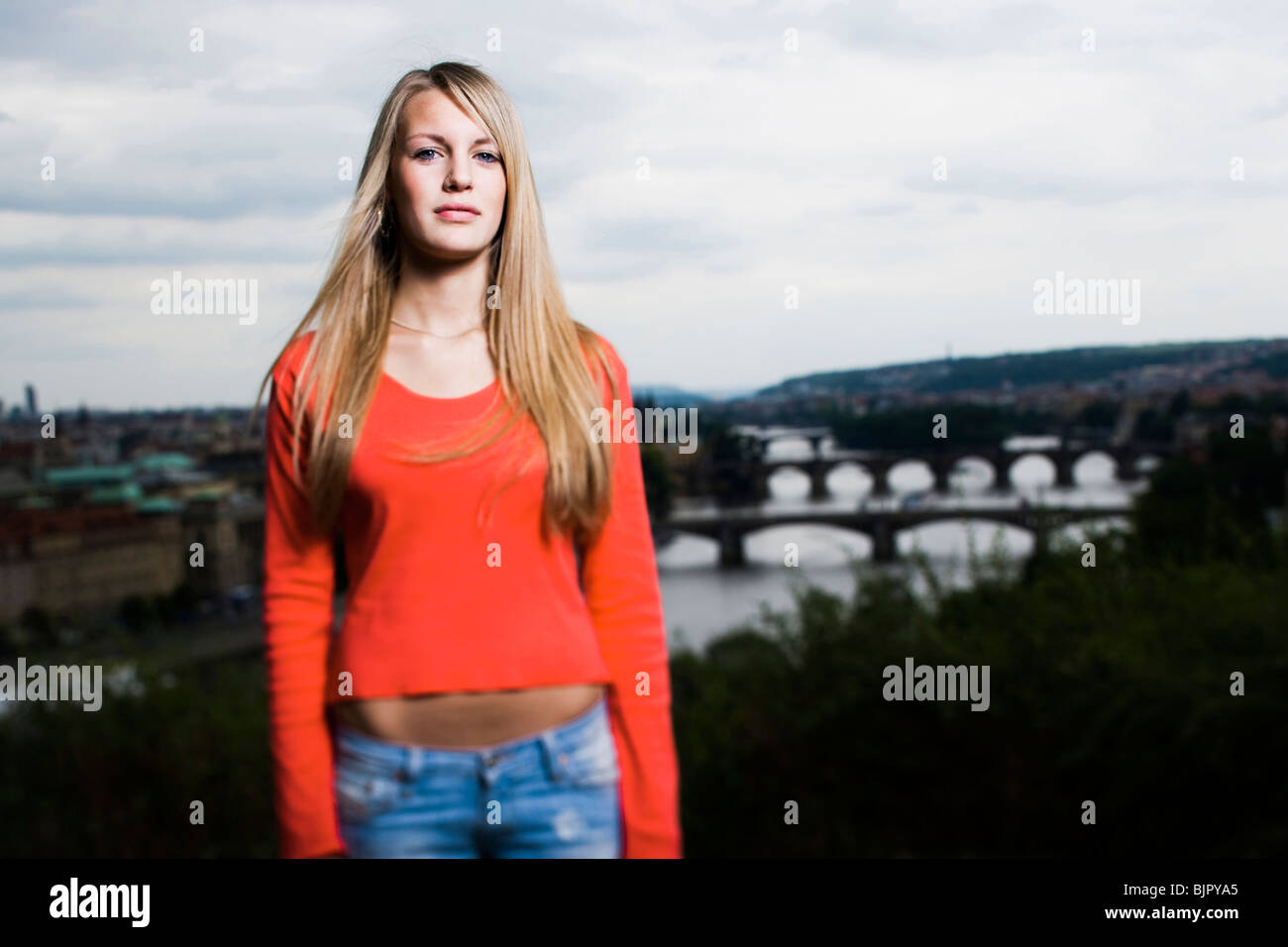 Woman outside in front of bridges Stock Photo - Alamy