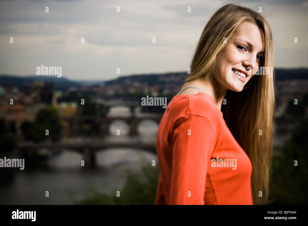 Woman outside in front of bridges Stock Photo - Alamy