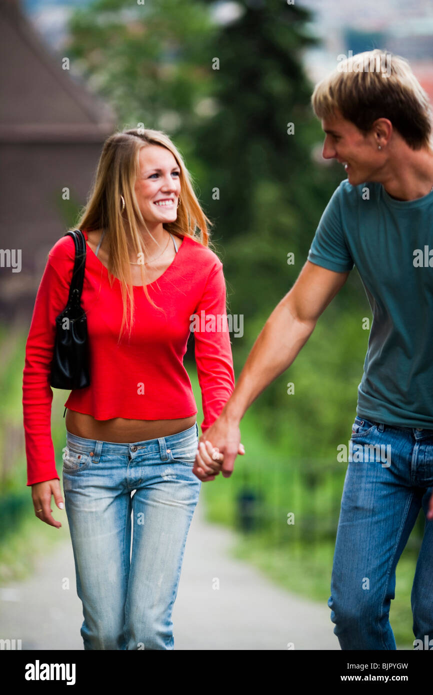 Couple walking and holding hands Stock Photo - Alamy