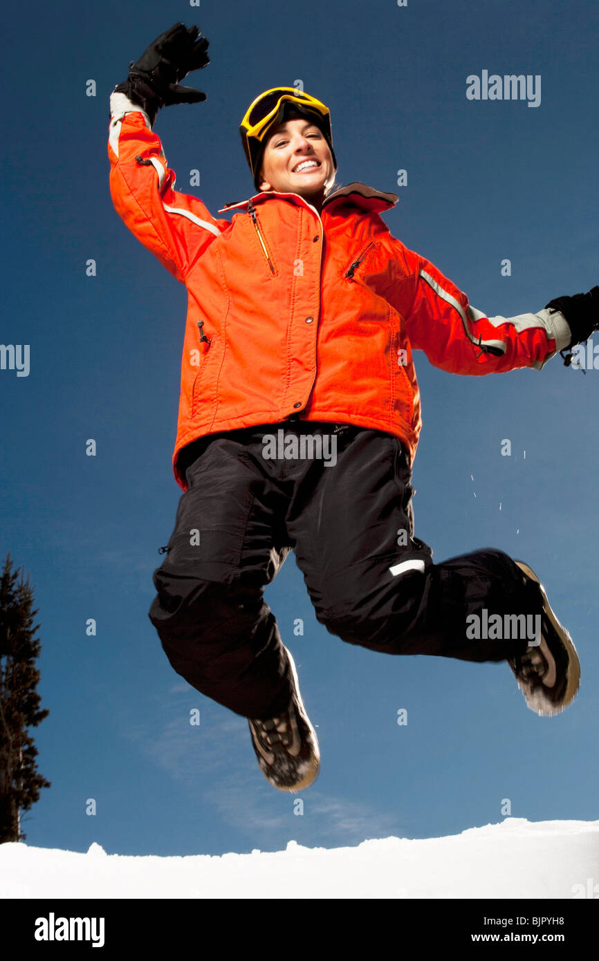 Woman jumping outside in the snow Stock Photo - Alamy