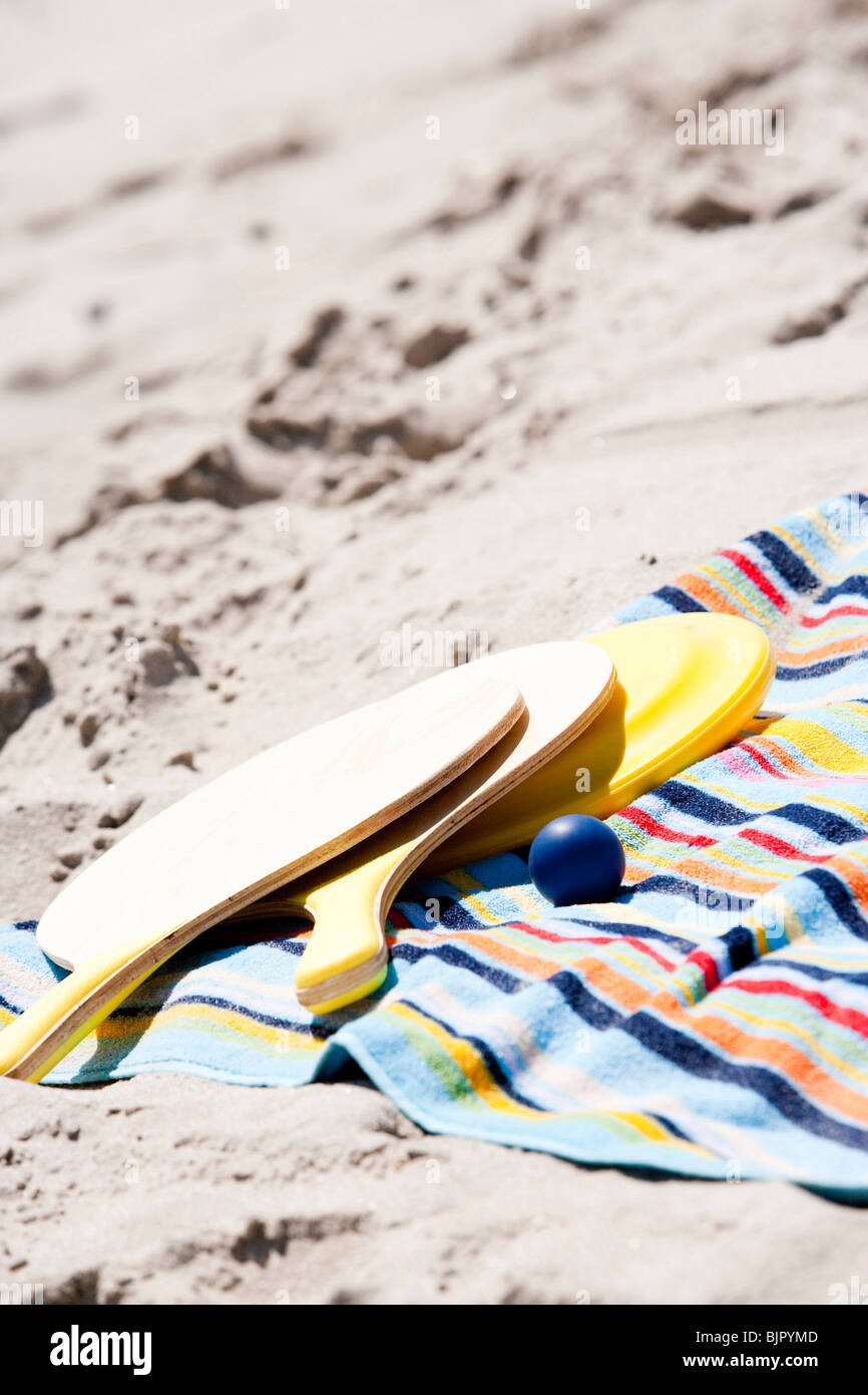 Paddles on a towel at the beach Stock Photo - Alamy