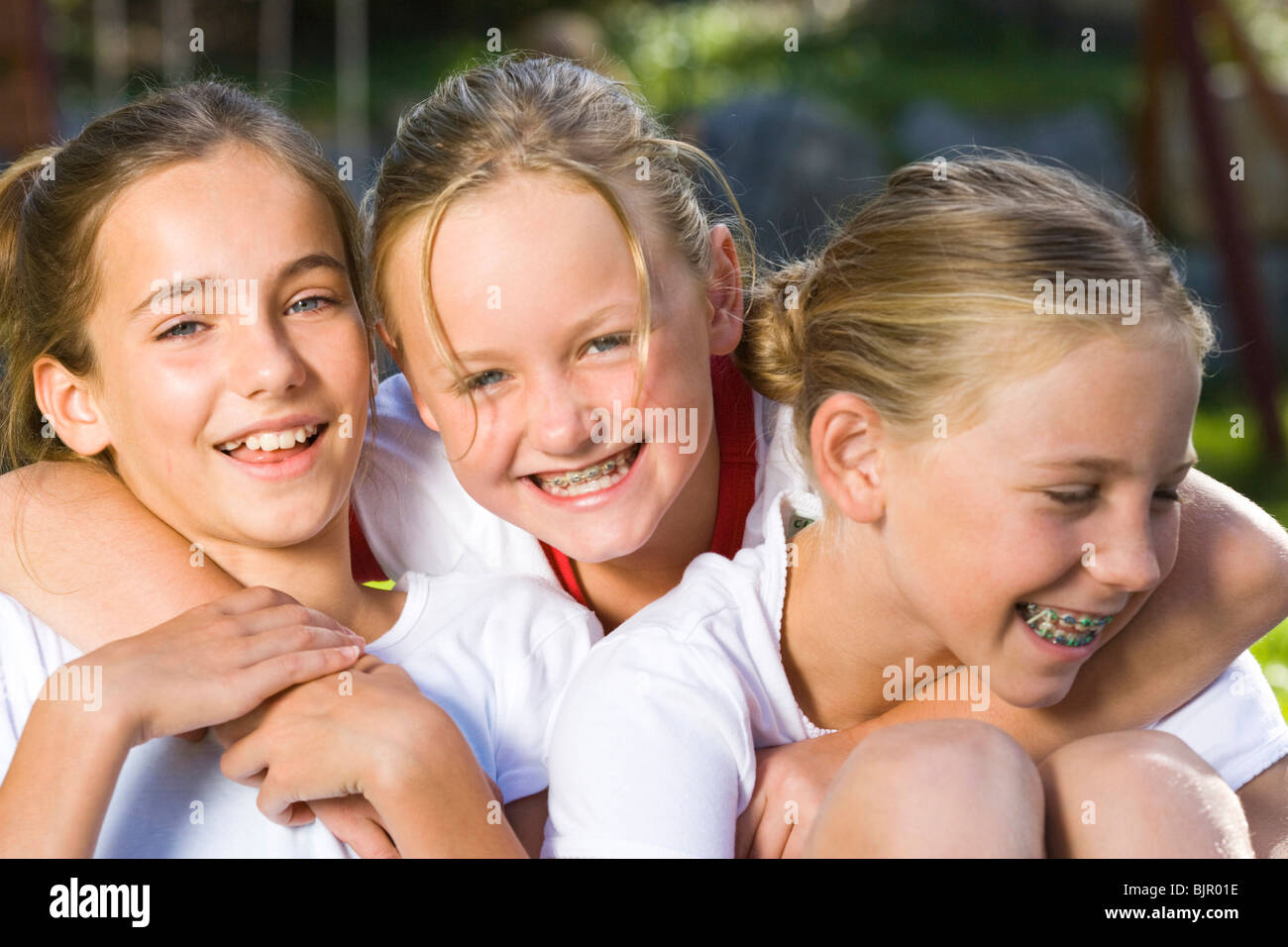 Three girls smiling Stock Photo - Alamy