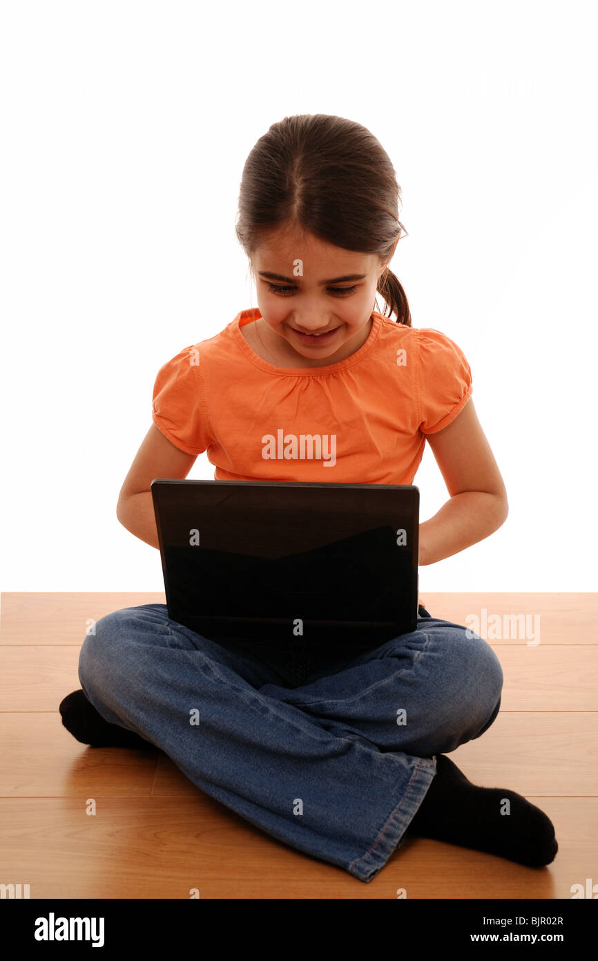 Young girl happily using a laptop Stock Photo - Alamy