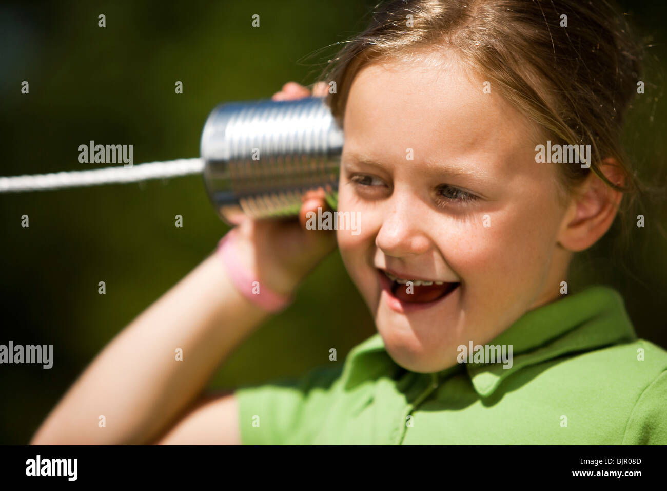 Girl on tin can phone Stock Photo - Alamy