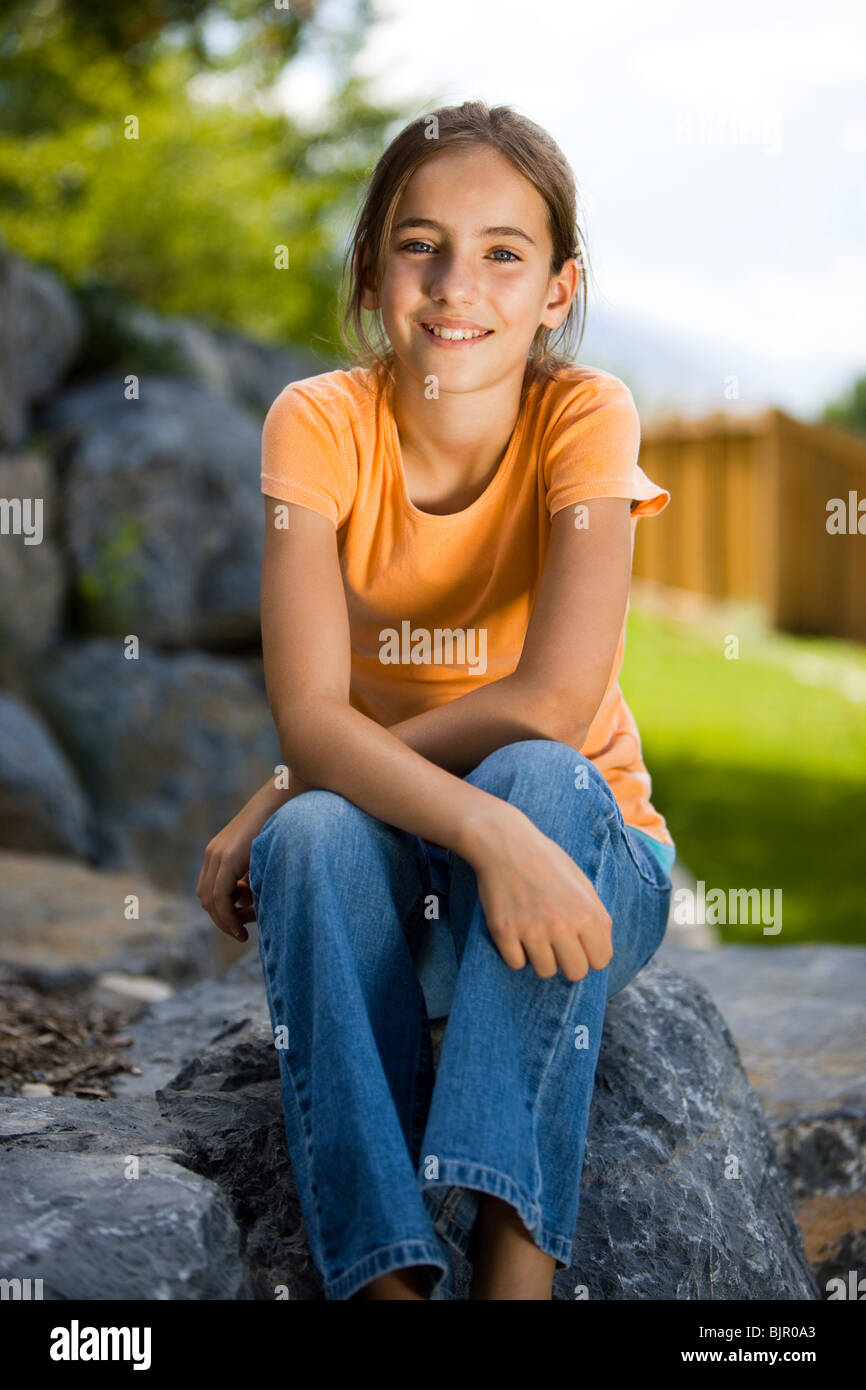 Girl sitting outside Stock Photo - Alamy