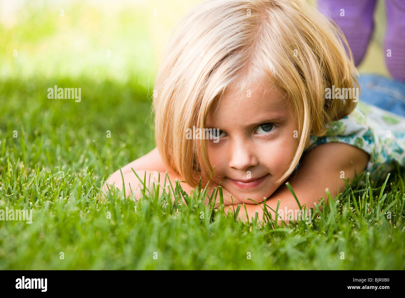 Girl lying on stomach Stock Photo - Alamy