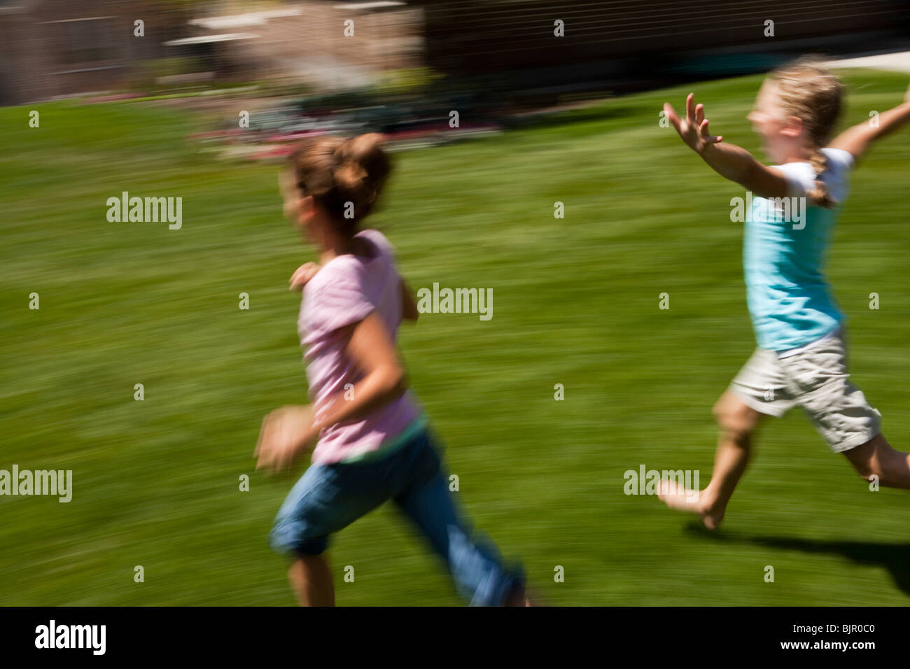 Three girl friends running outside Stock Photo - Alamy