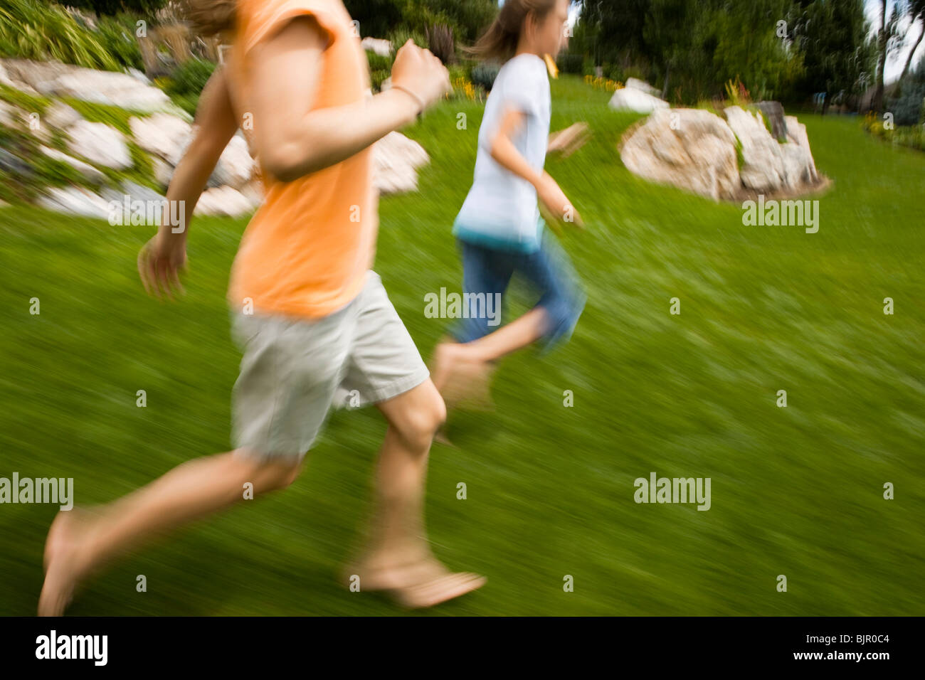 Three girl friends running outside Stock Photo - Alamy