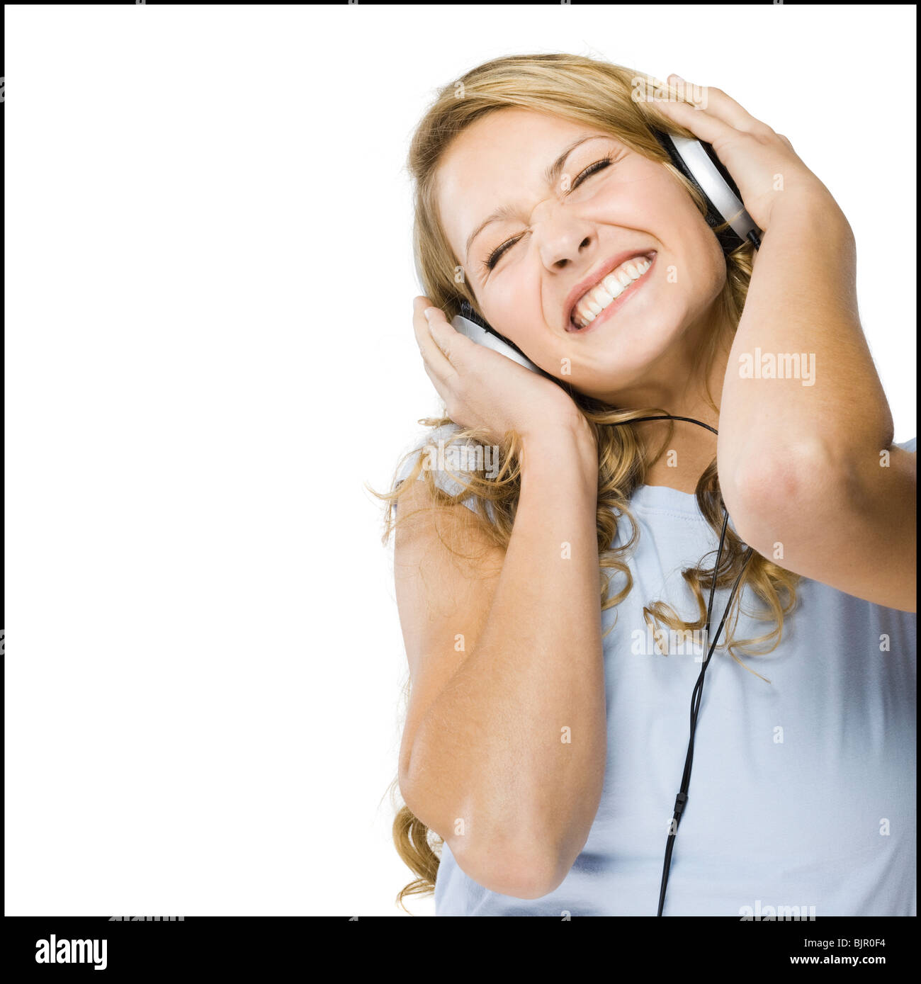 young woman listening to earphones Stock Photo - Alamy