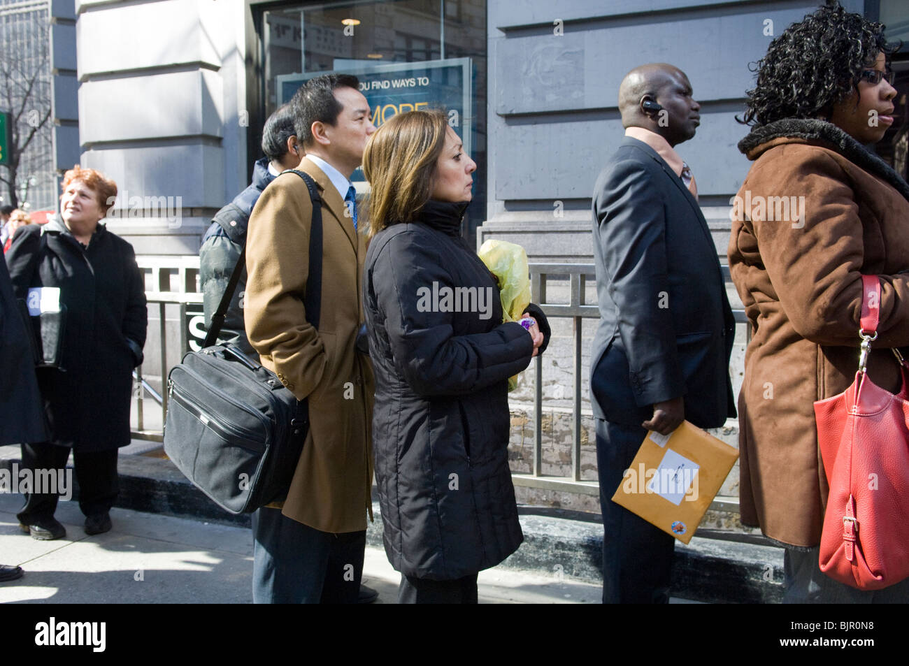 Job seekers line up for a job fair in midtown in New York on Wednesday ...