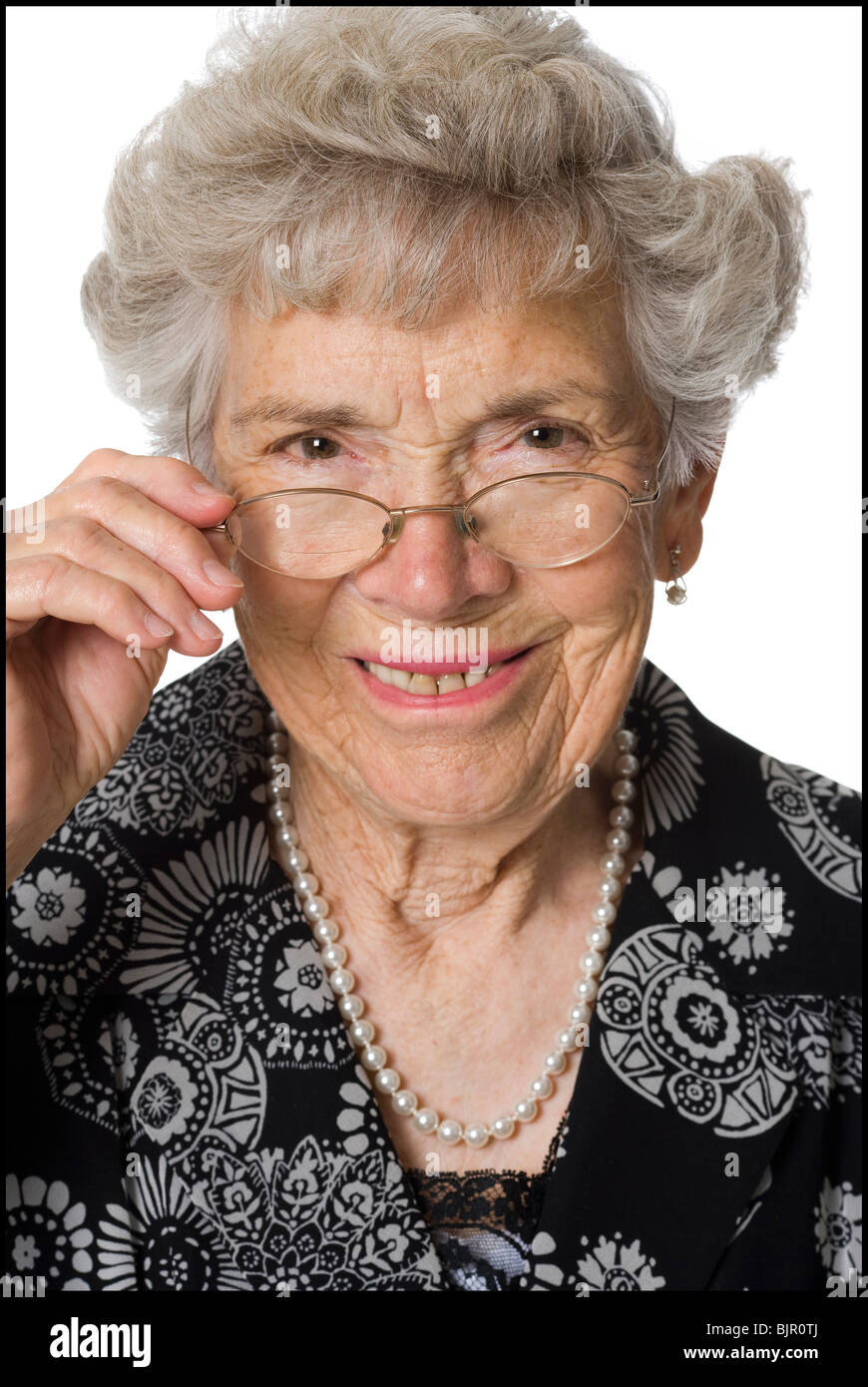 Senior woman with glasses looking sternly at camera Stock Photo - Alamy