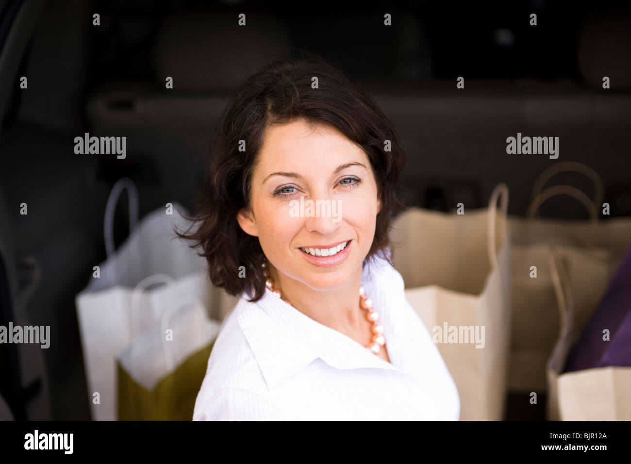 Woman with packages behind her Stock Photo - Alamy