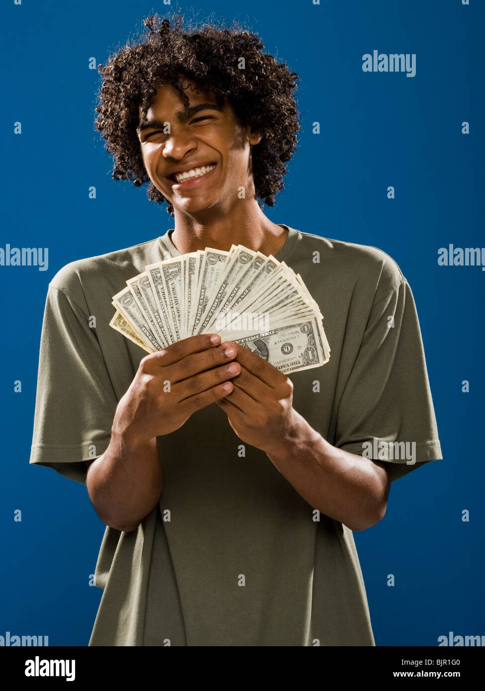 young man holding money Stock Photo - Alamy
