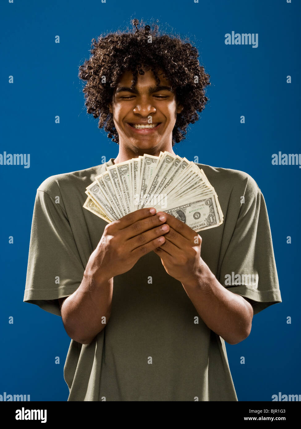 young man holding money Stock Photo - Alamy