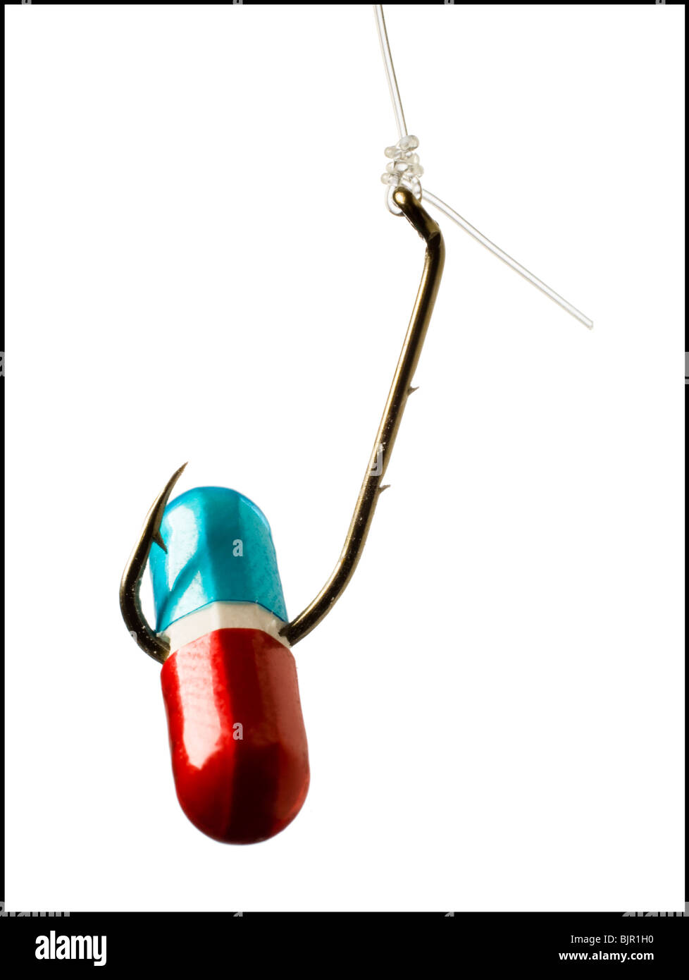 Pill on a fish hook Stock Photo - Alamy