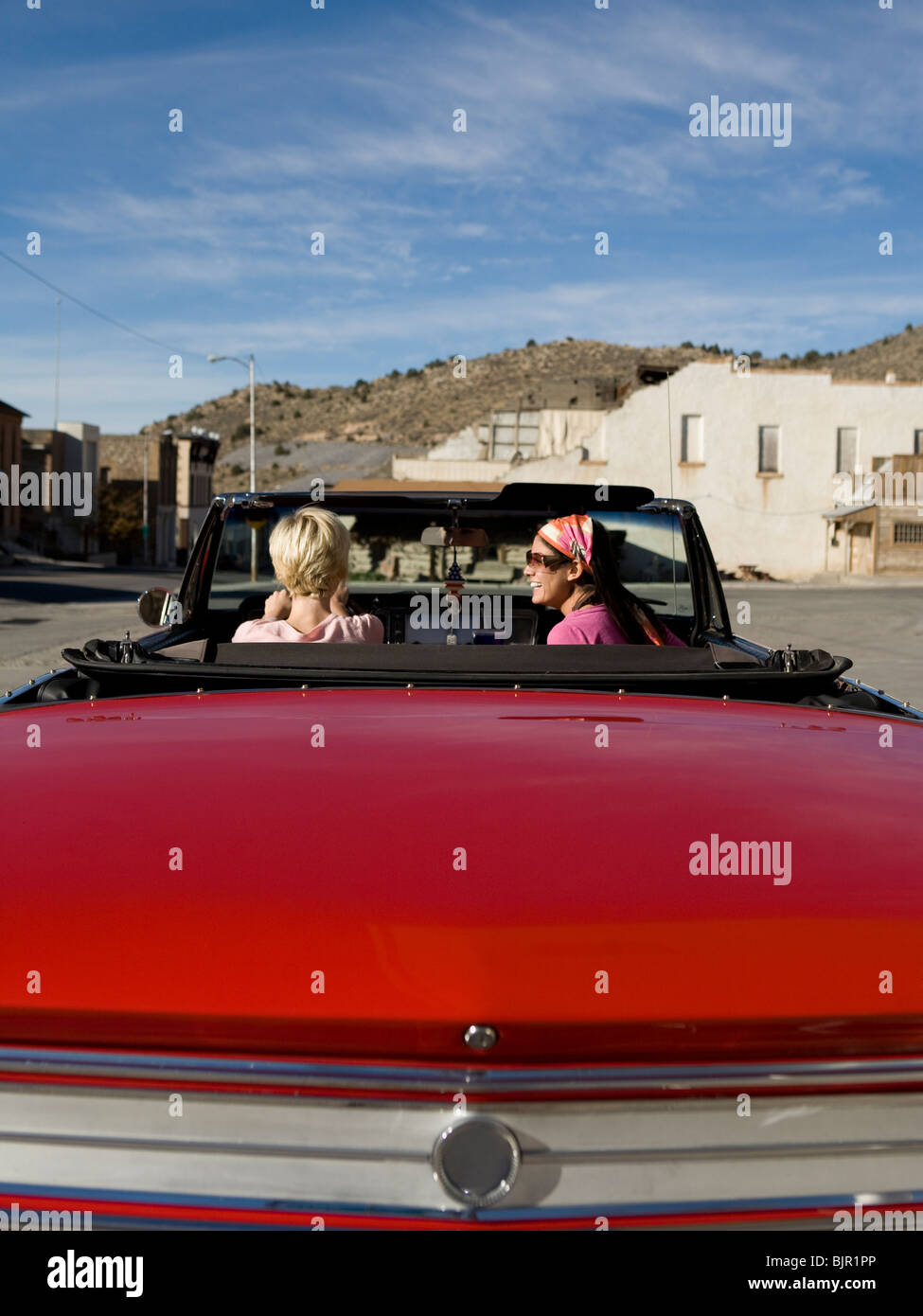 two women in a red convertible Stock Photo - Alamy