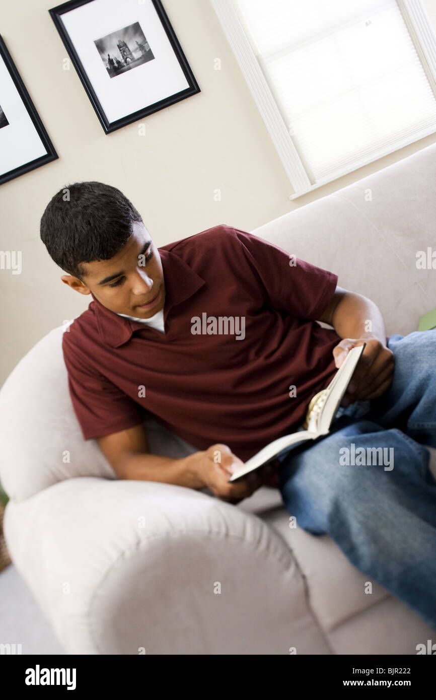 Teenage boy reading a book Stock Photo - Alamy