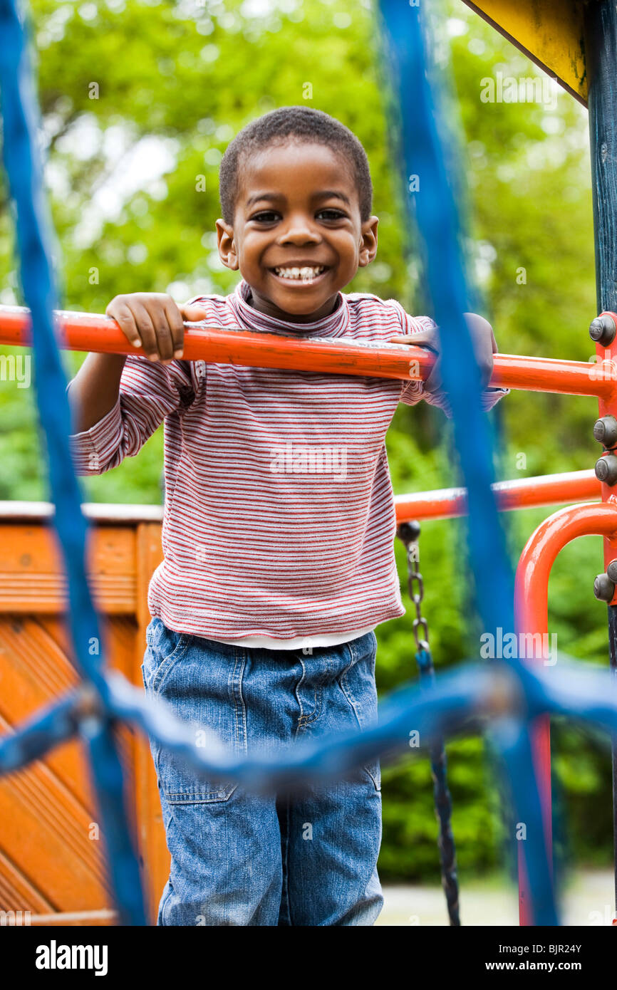 Boy playing in playground Stock Photo - Alamy