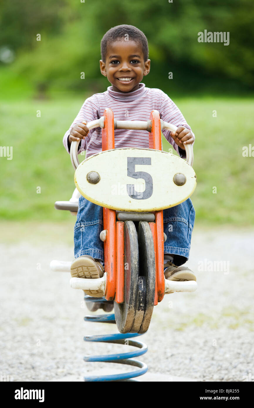 Boy playing in playground Stock Photo - Alamy