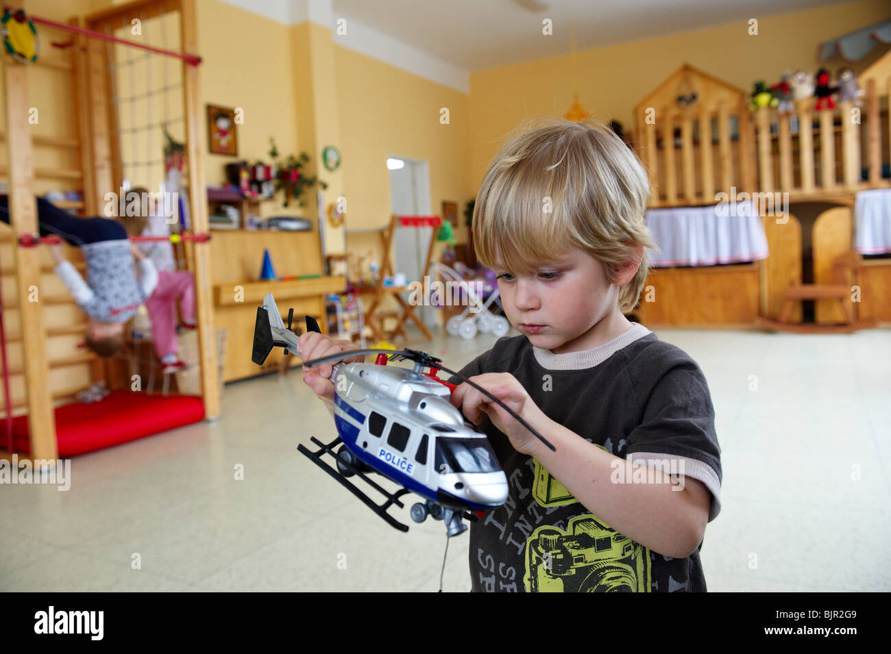 Preschool children playing in class with toys Stock Photo - Alamy
