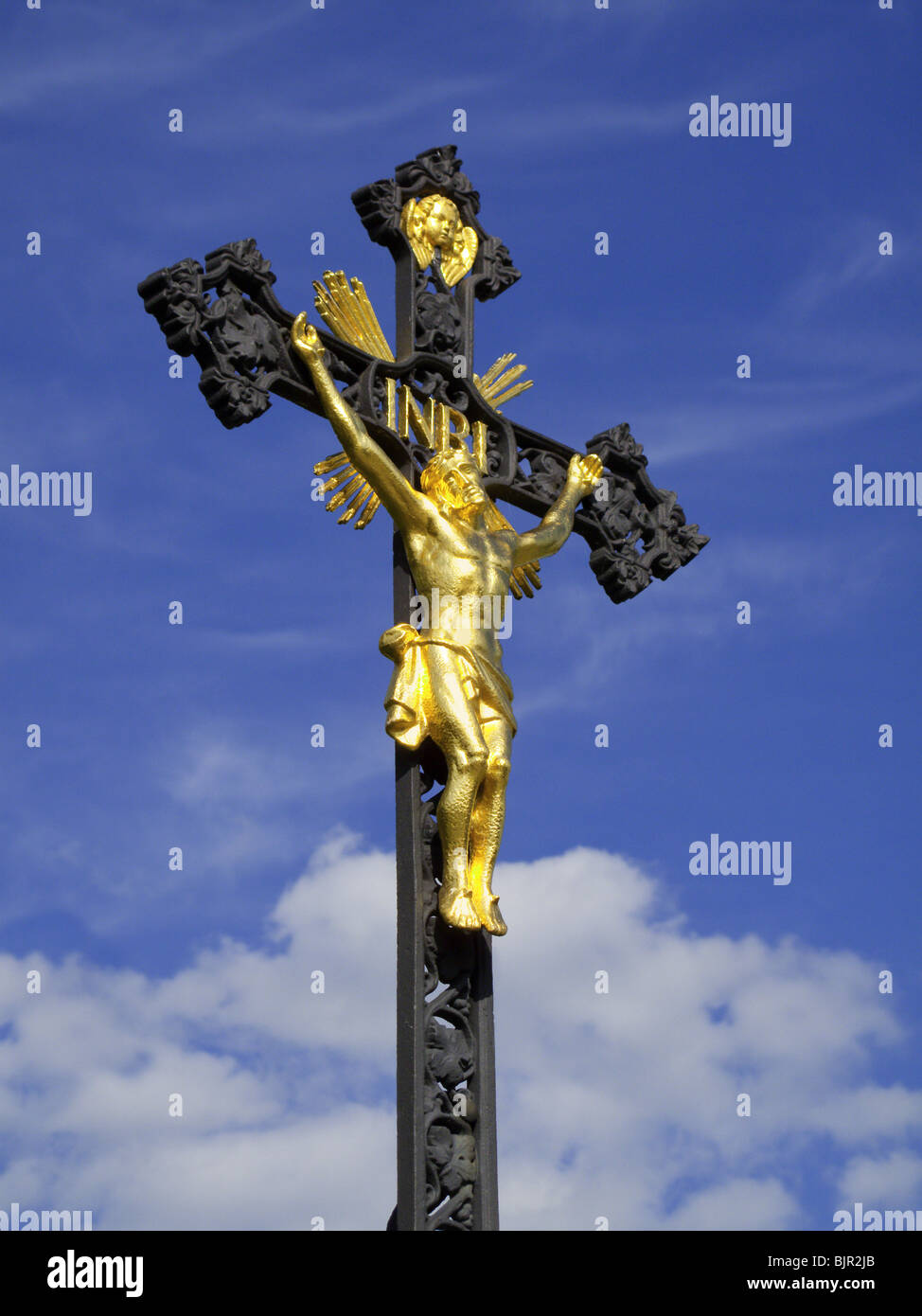 Gilded sculpture of Jesus Christ on iron cast crucifix Stock Photo - Alamy