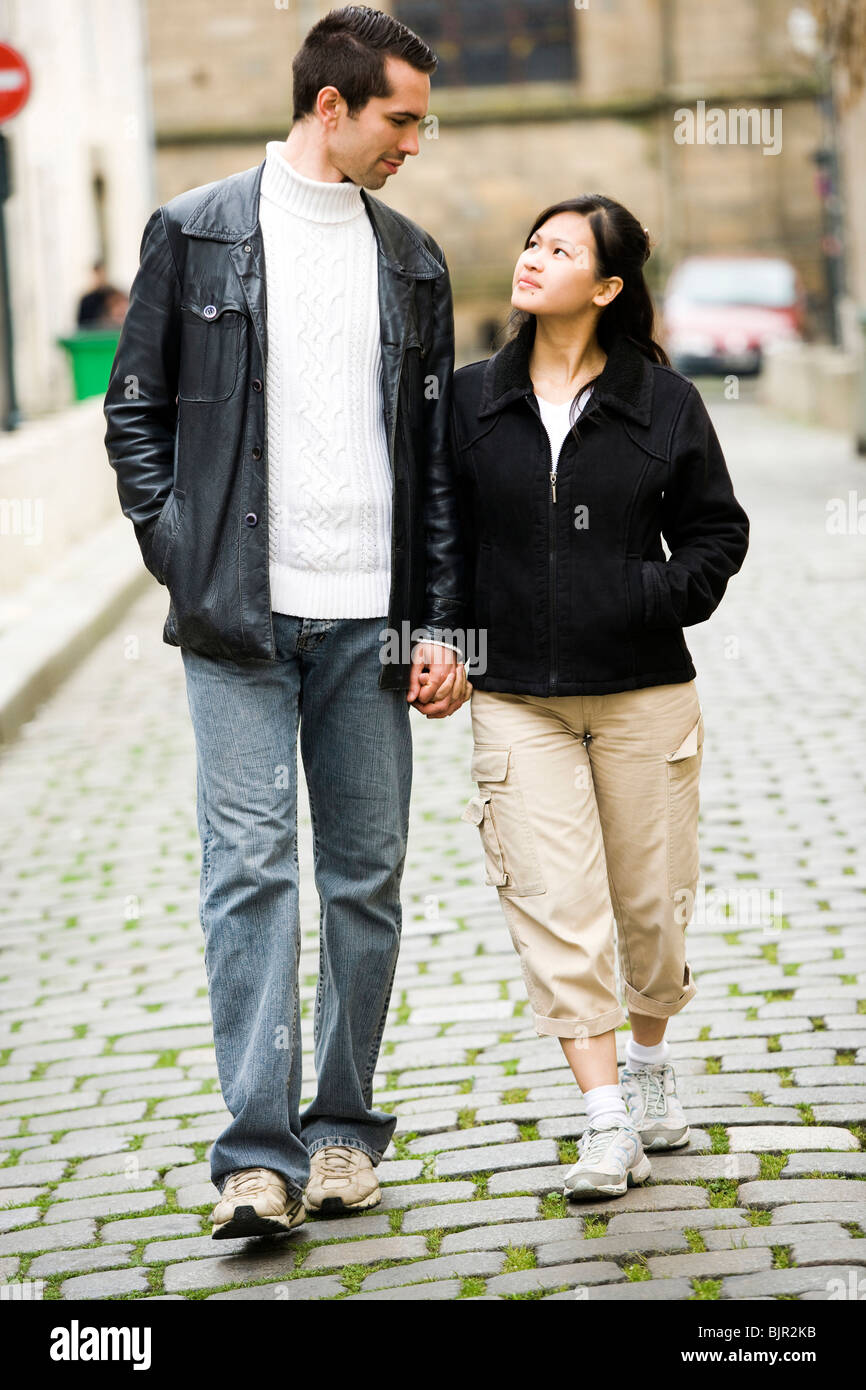 Young woman strolling down street hi-res stock photography and images ...