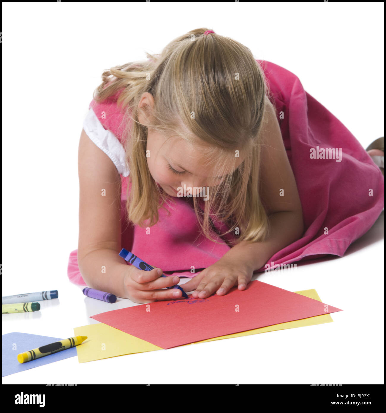 Girl drawing with crayons Stock Photo - Alamy