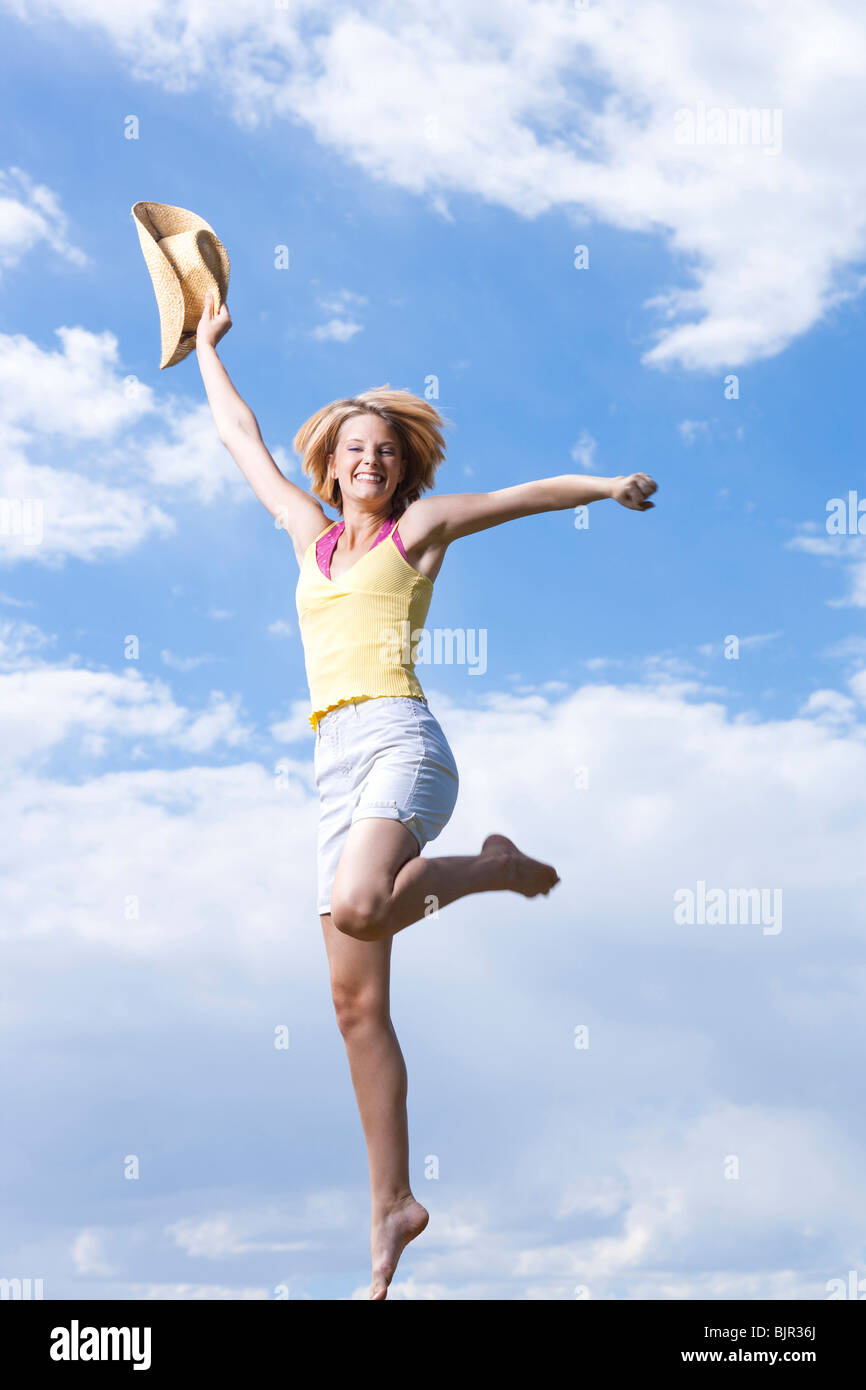 Woman jumping with a cowboy hat Stock Photo - Alamy