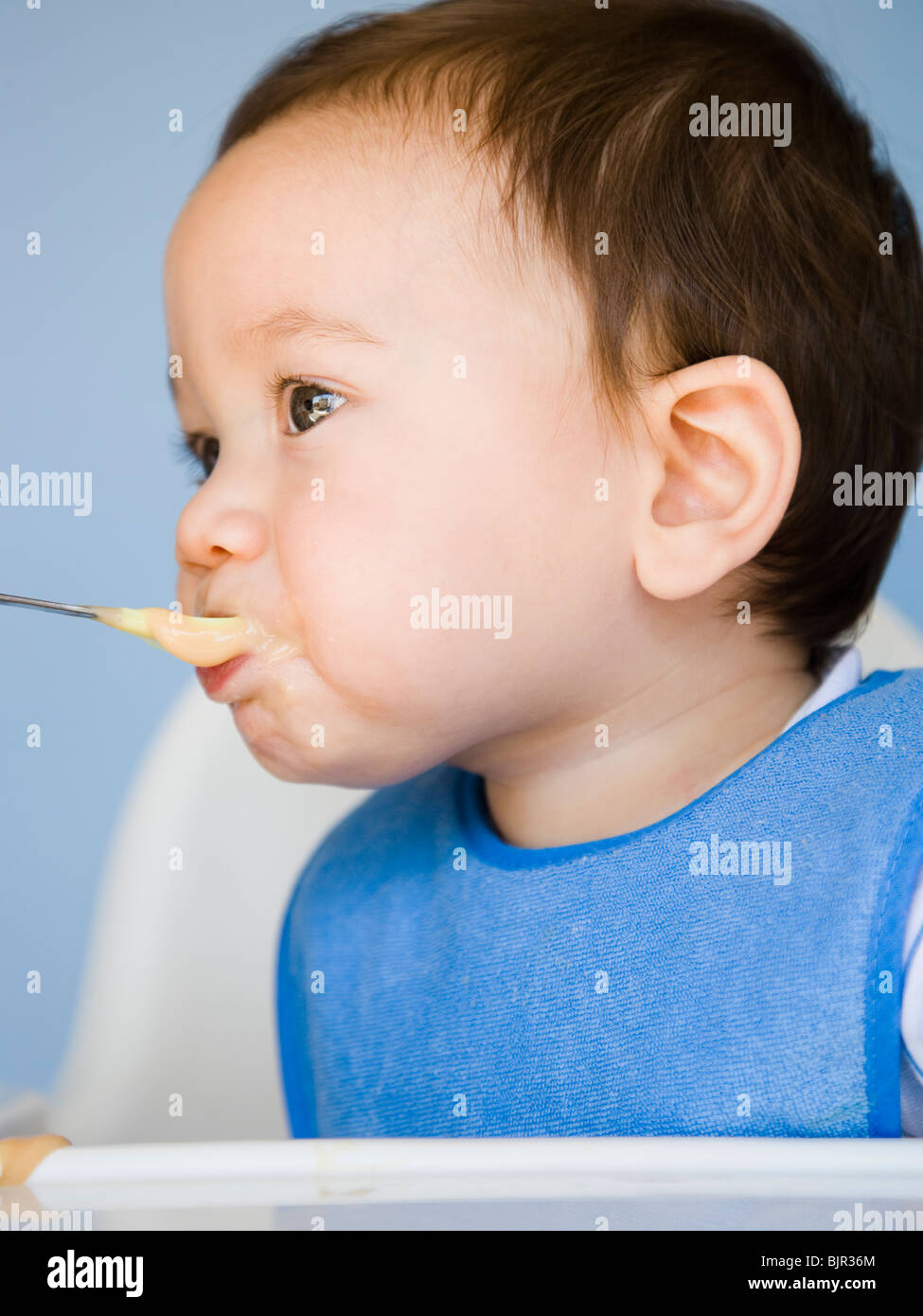 baby boy with a blue bib Stock Photo - Alamy
