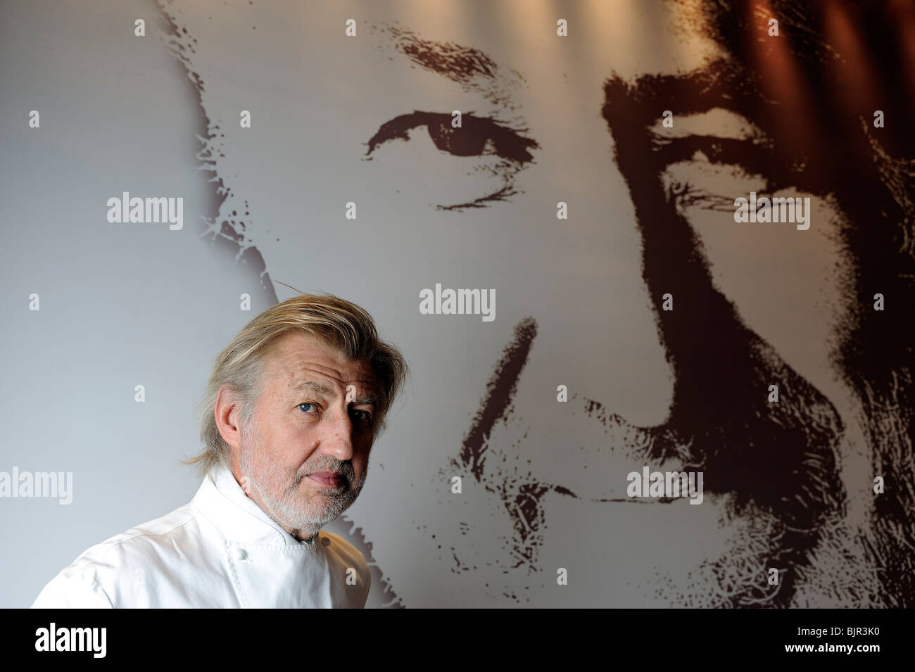 French chef Pierre Gagnaire poses with a glass of wine at his ...